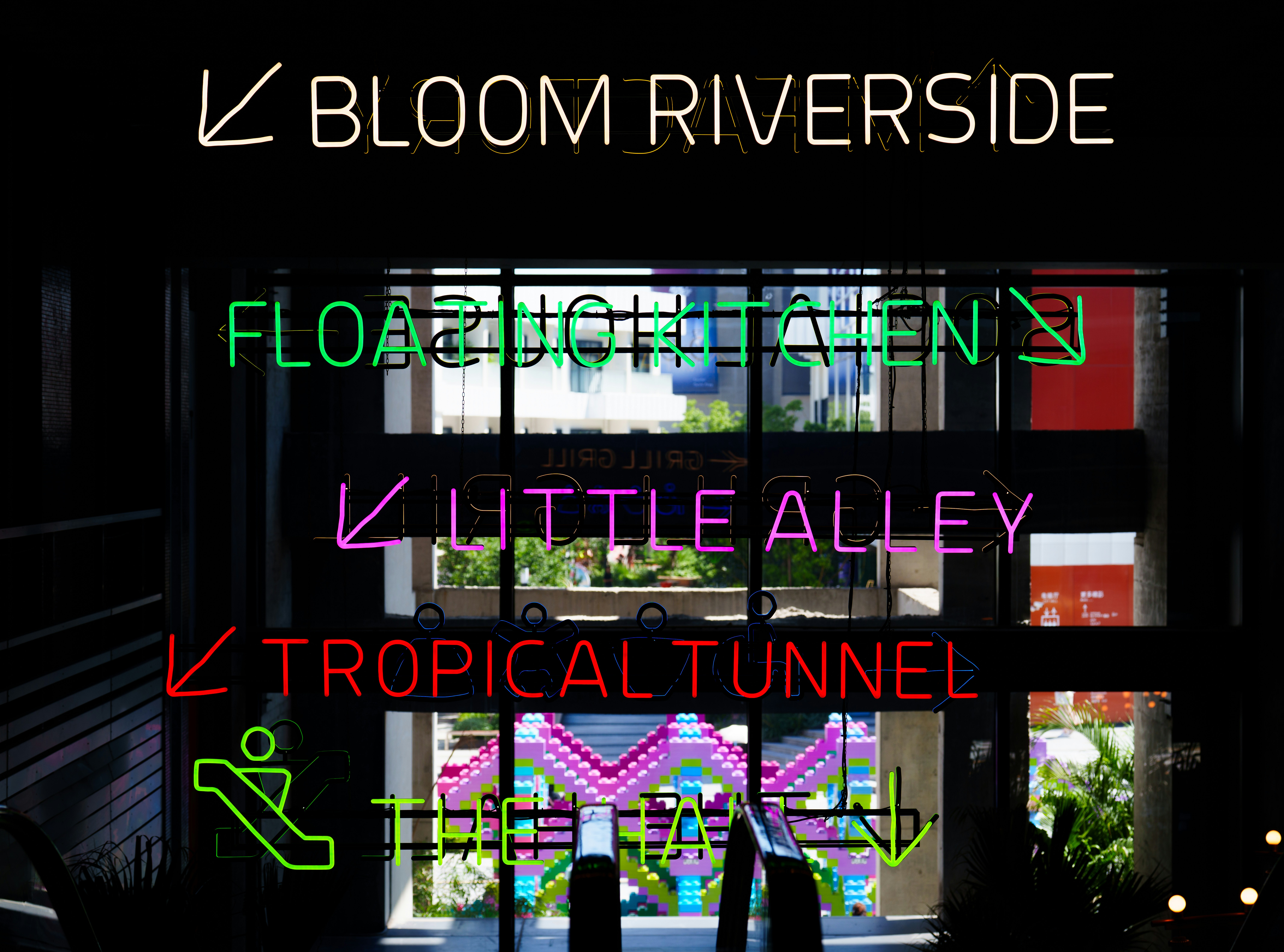 Neon Layering Inside Bloom Riverside: Floating Kitchen, Little Alley, and Tropical Tunnel