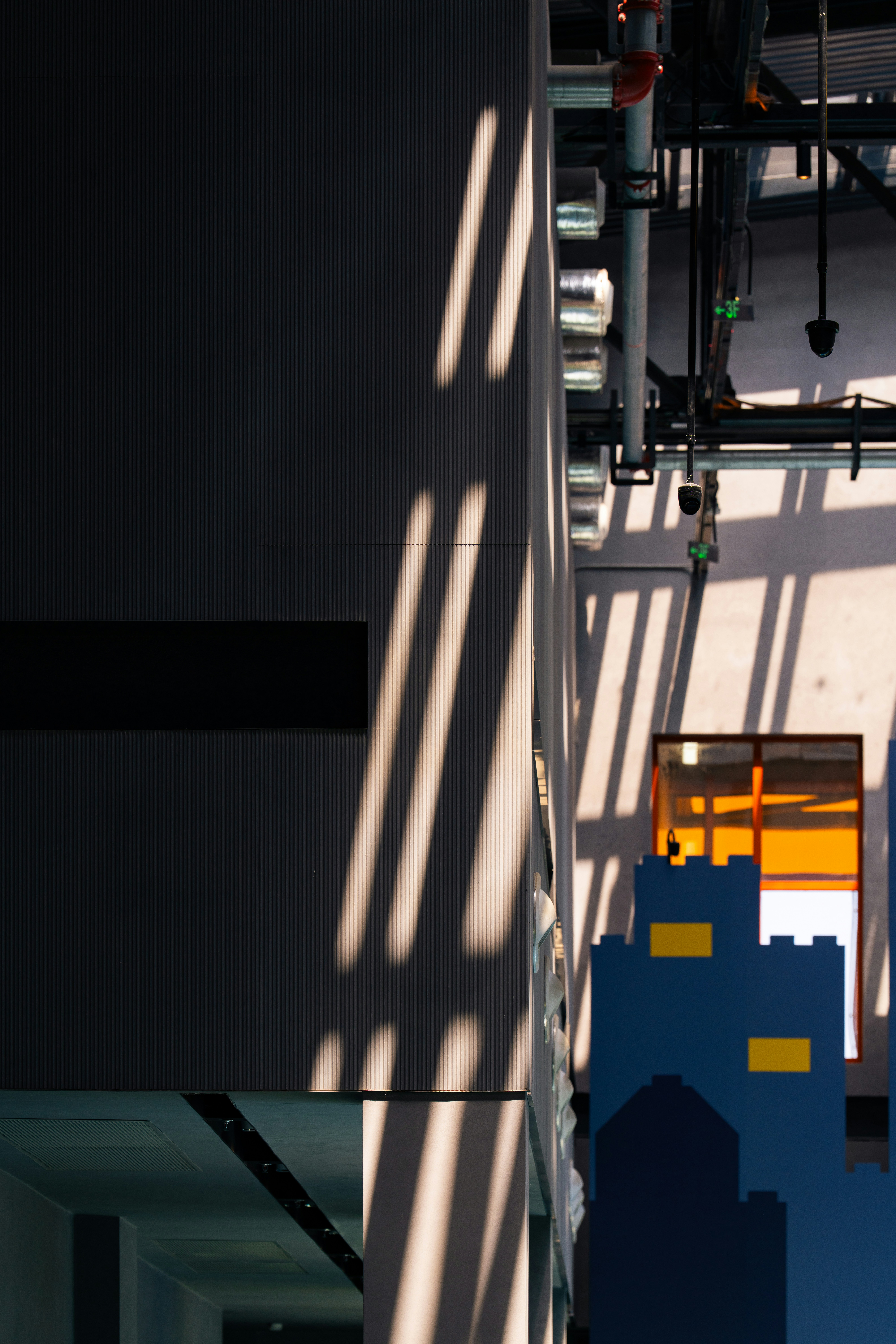 Crisscrossed Light and Color: An Industrial Atrium’s Playful Block City