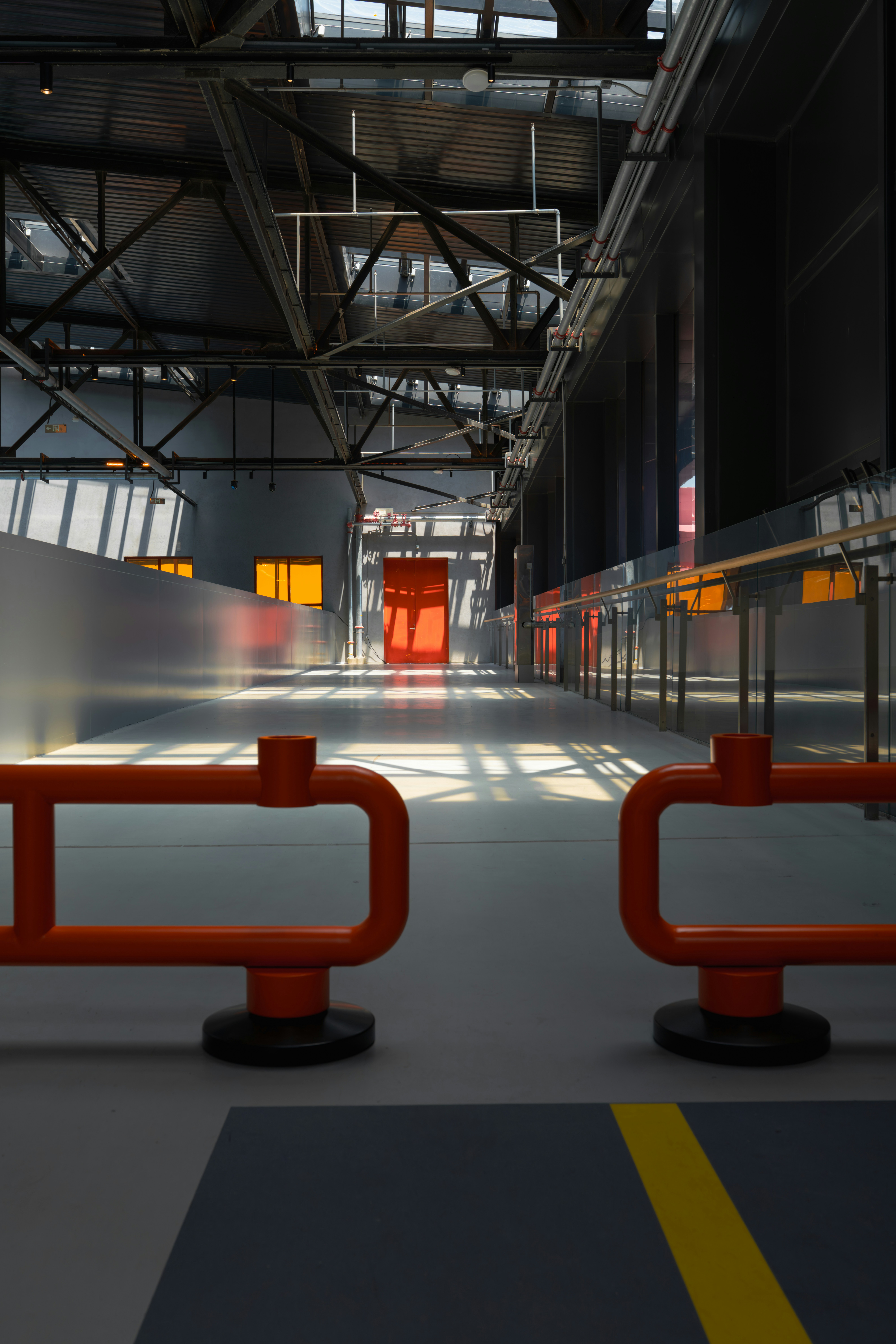 An industrial-looking hall with orange accents.