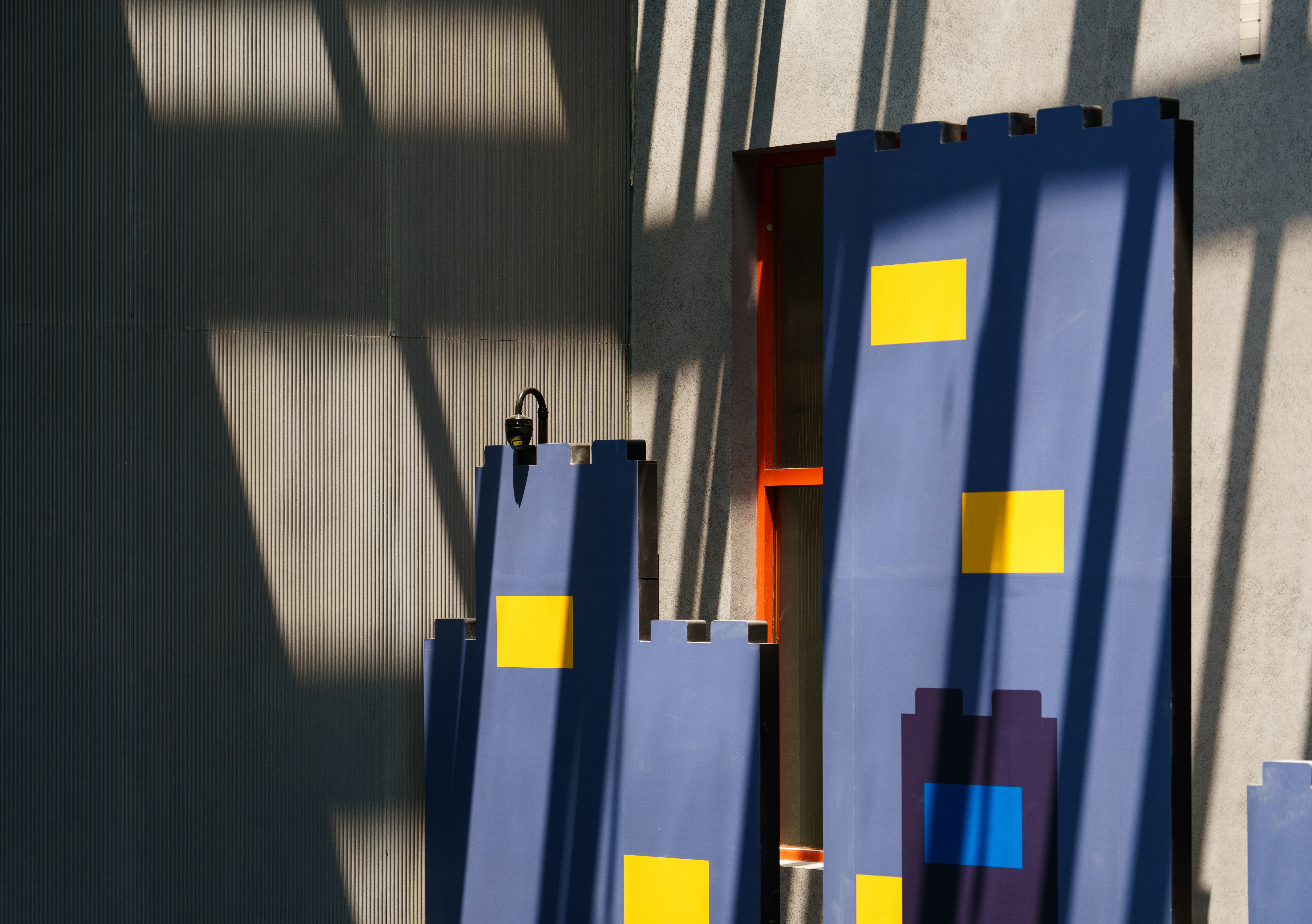 Abstract artwork in the corner of a building.