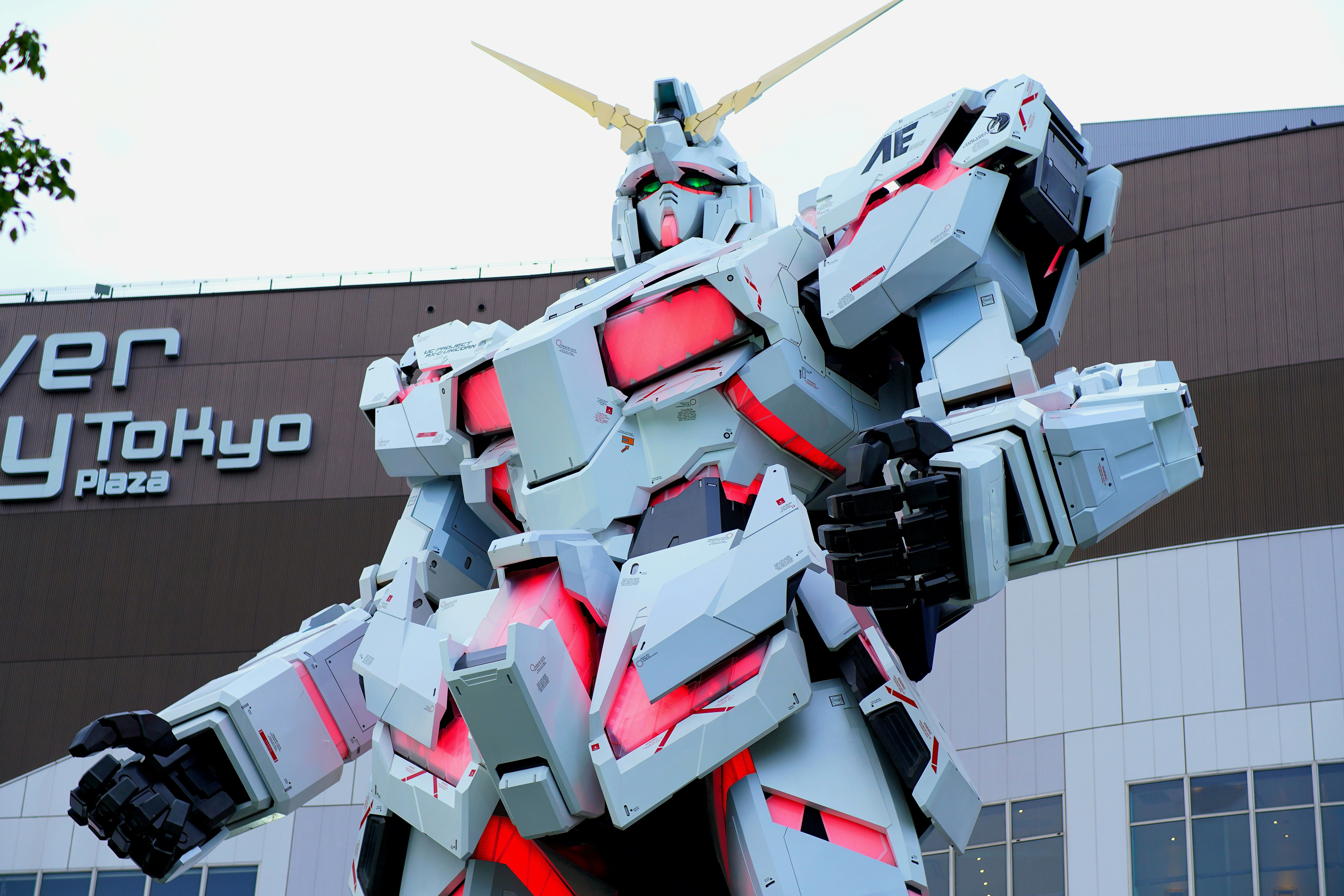 Giant Gundam statue towering outside DiverCity Tokyo Plaza, showcasing intricate details and vibrant LED accents.