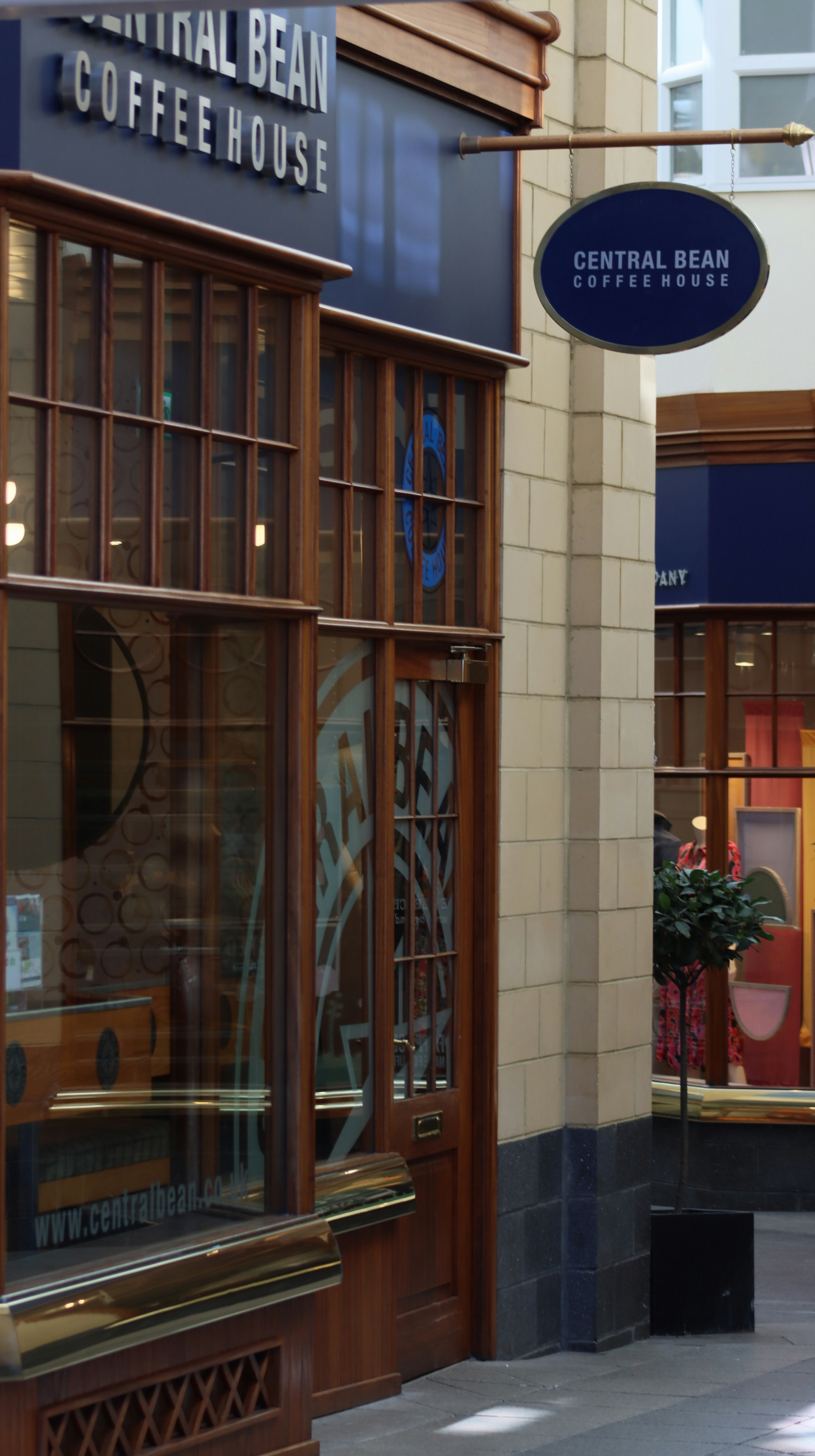 Blue Circular Sign Anchors the Central Bean Coffee House Facade