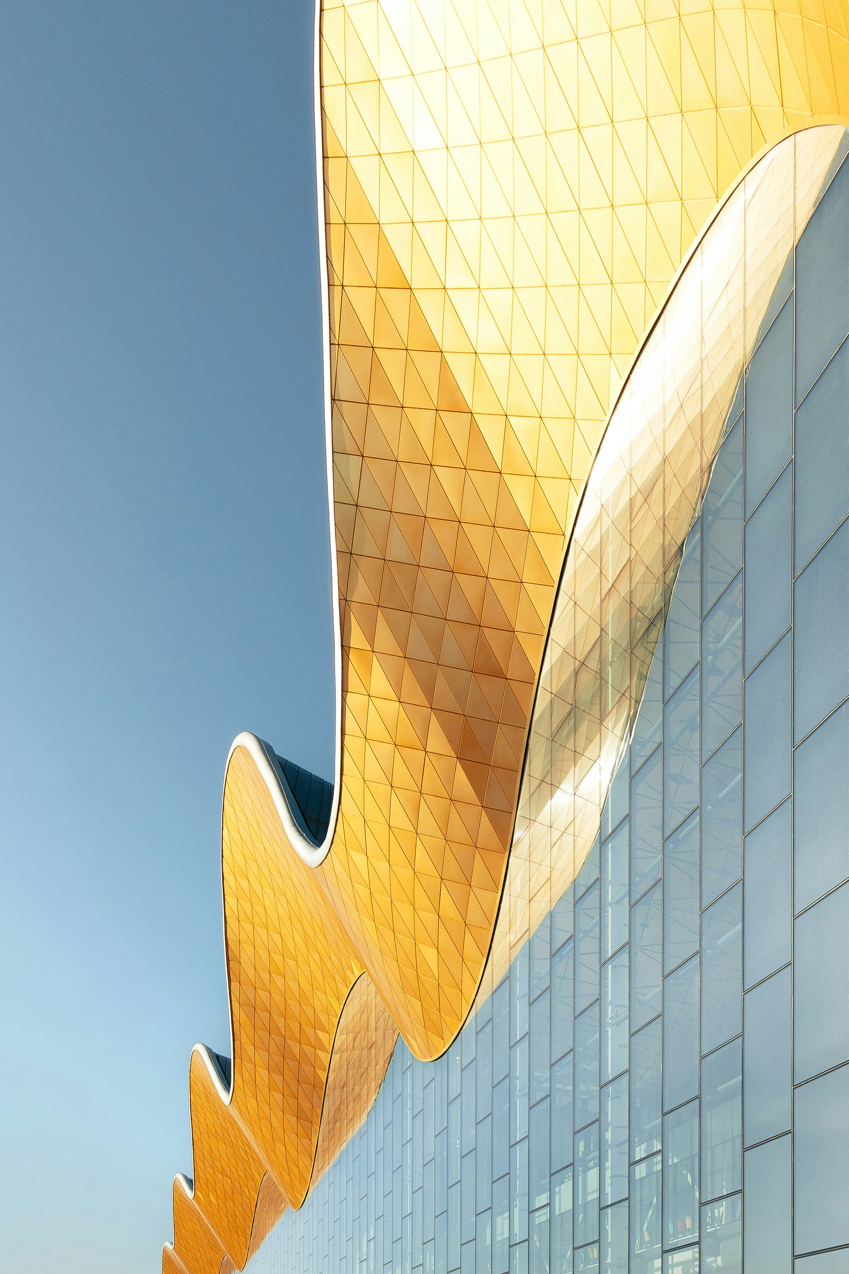 A modern building with gold, wavy facade. photo – Free Wallpaper Image ...