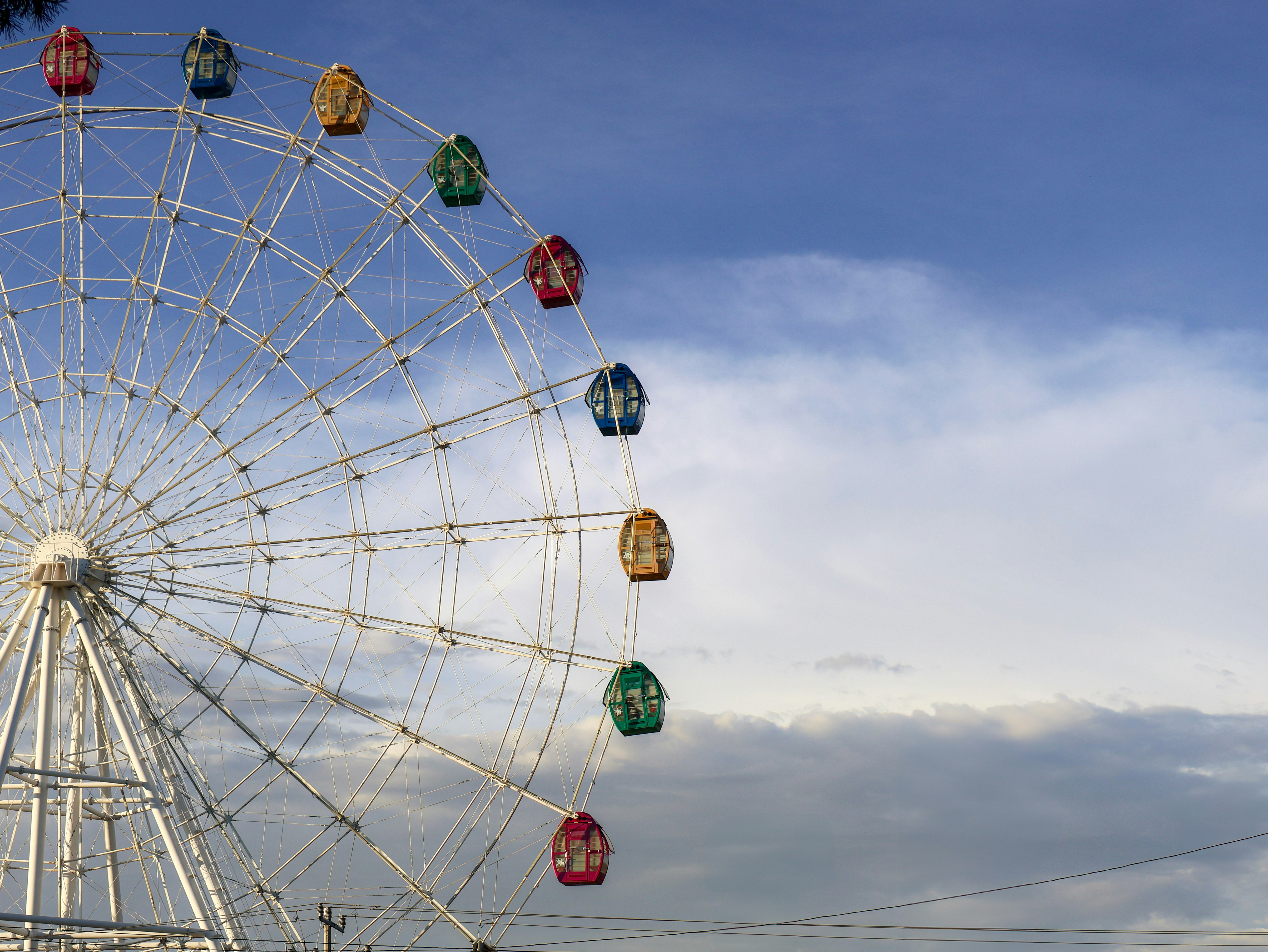 Whirl of Color: The Ferris Wheel's Dance Against the Sky