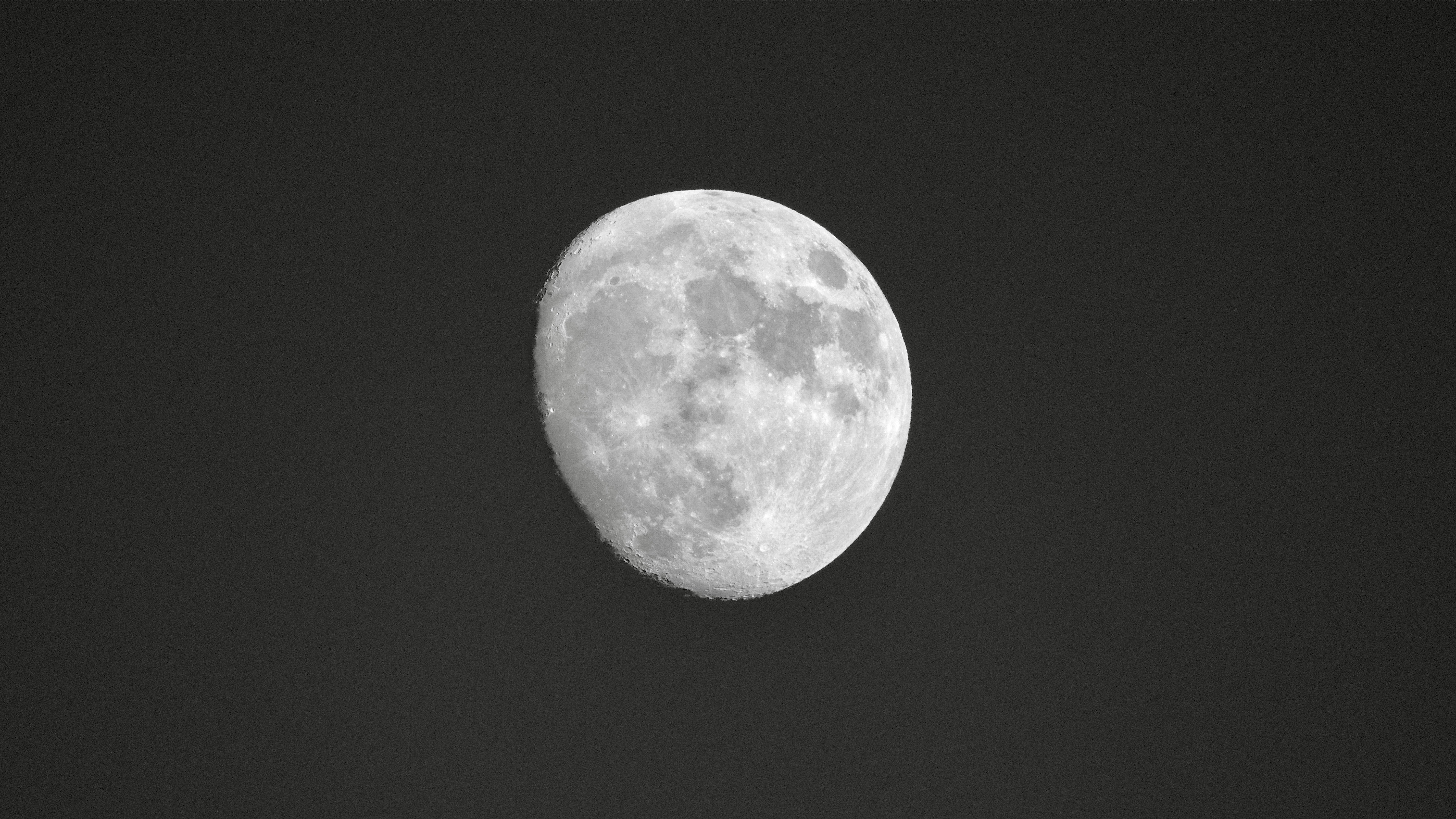 A moon shines brightly against a dark sky. photo – Free Space Image on ...