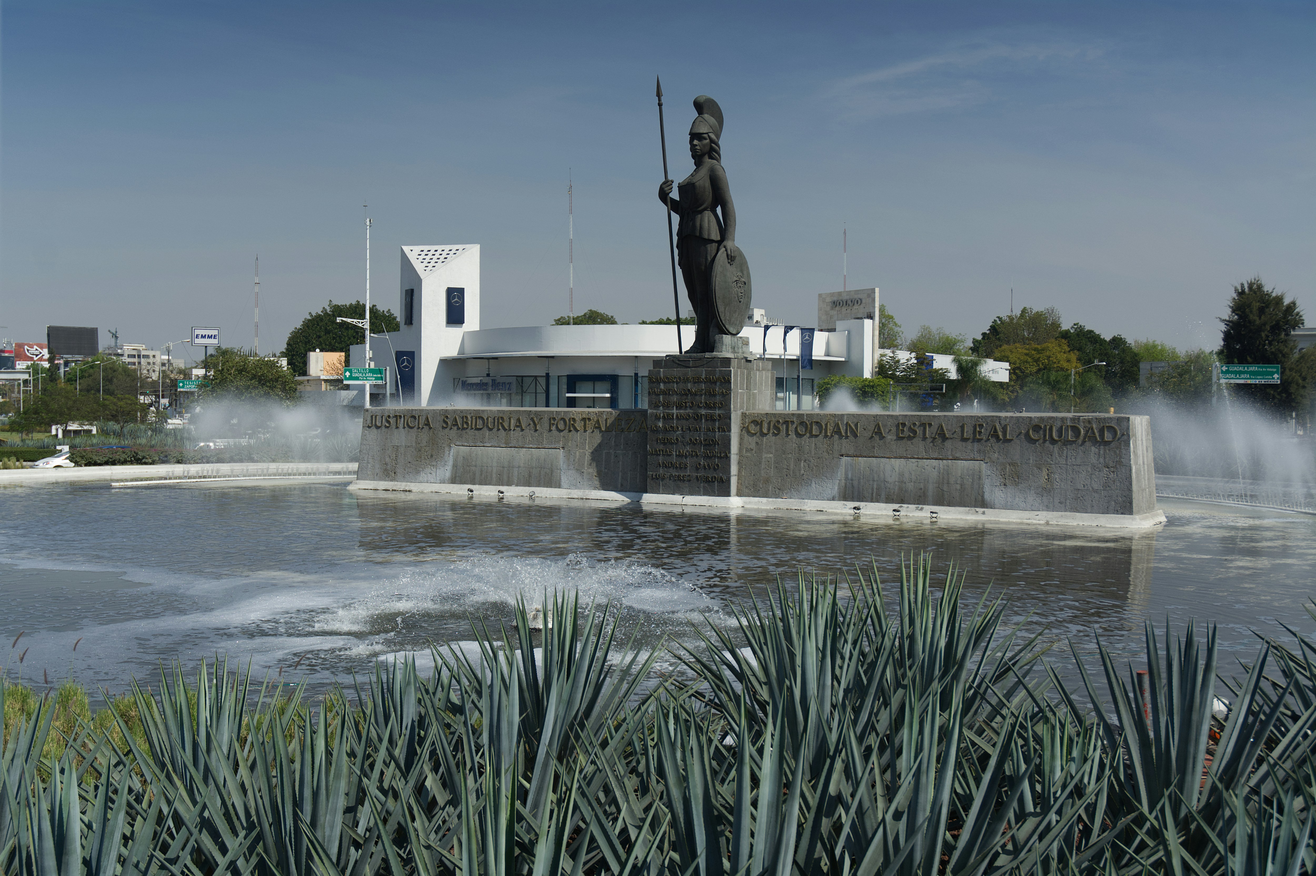 Fountain with Statue of Minerva | A statue stands above a fountain's splashing water.