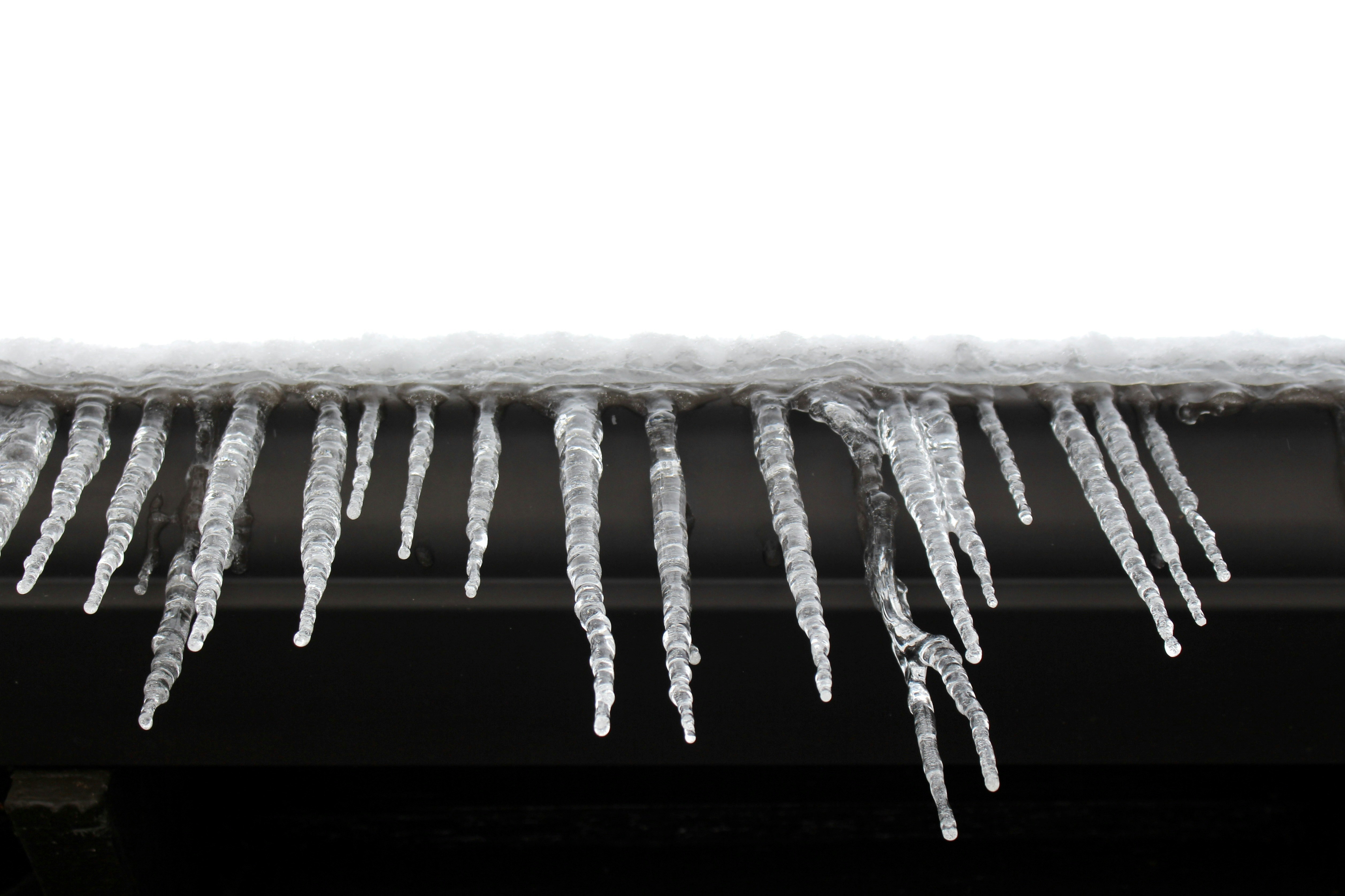 Icicles hanging from a snow-covered roof.