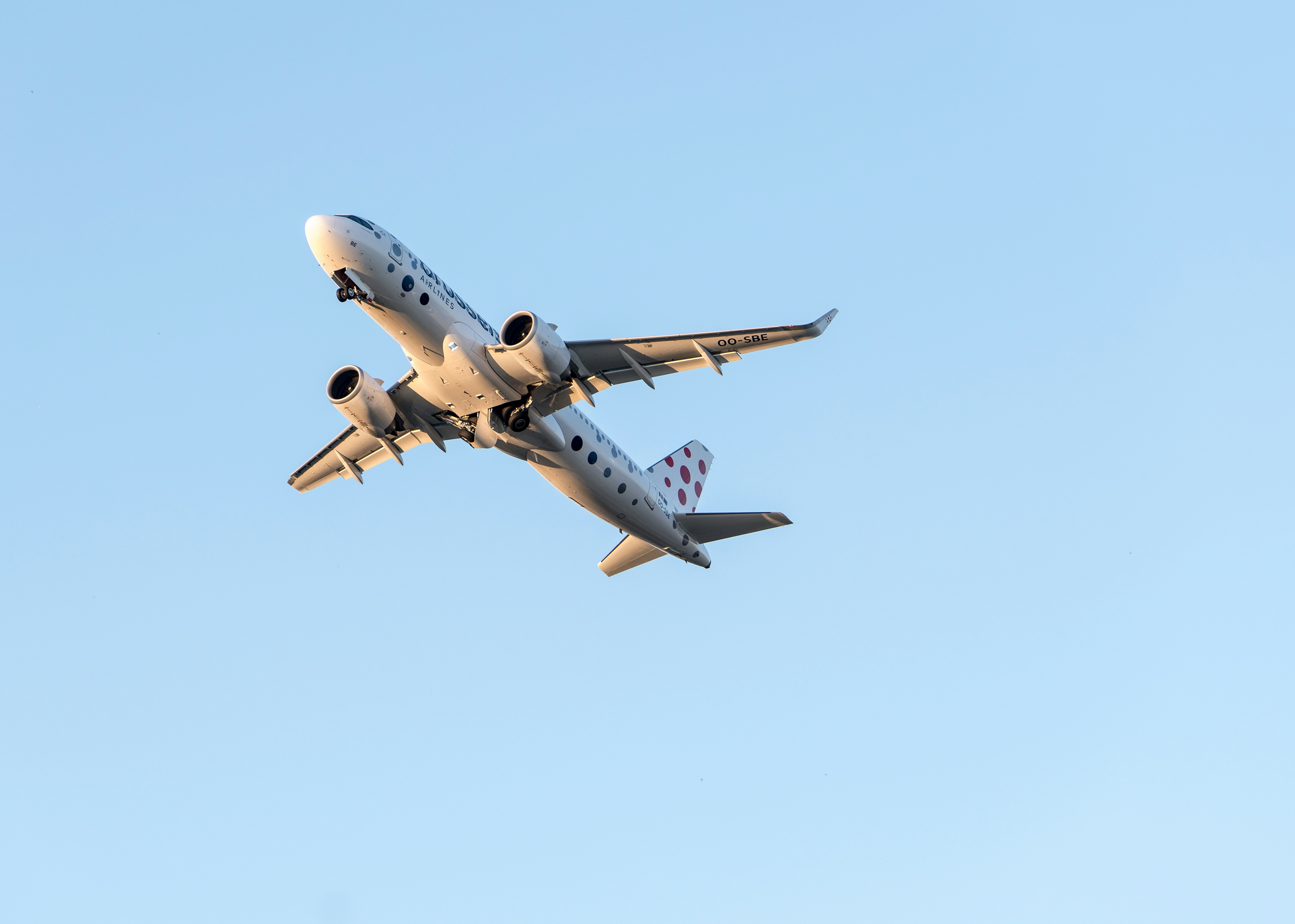 Airplane soars gracefully through the blue sky.