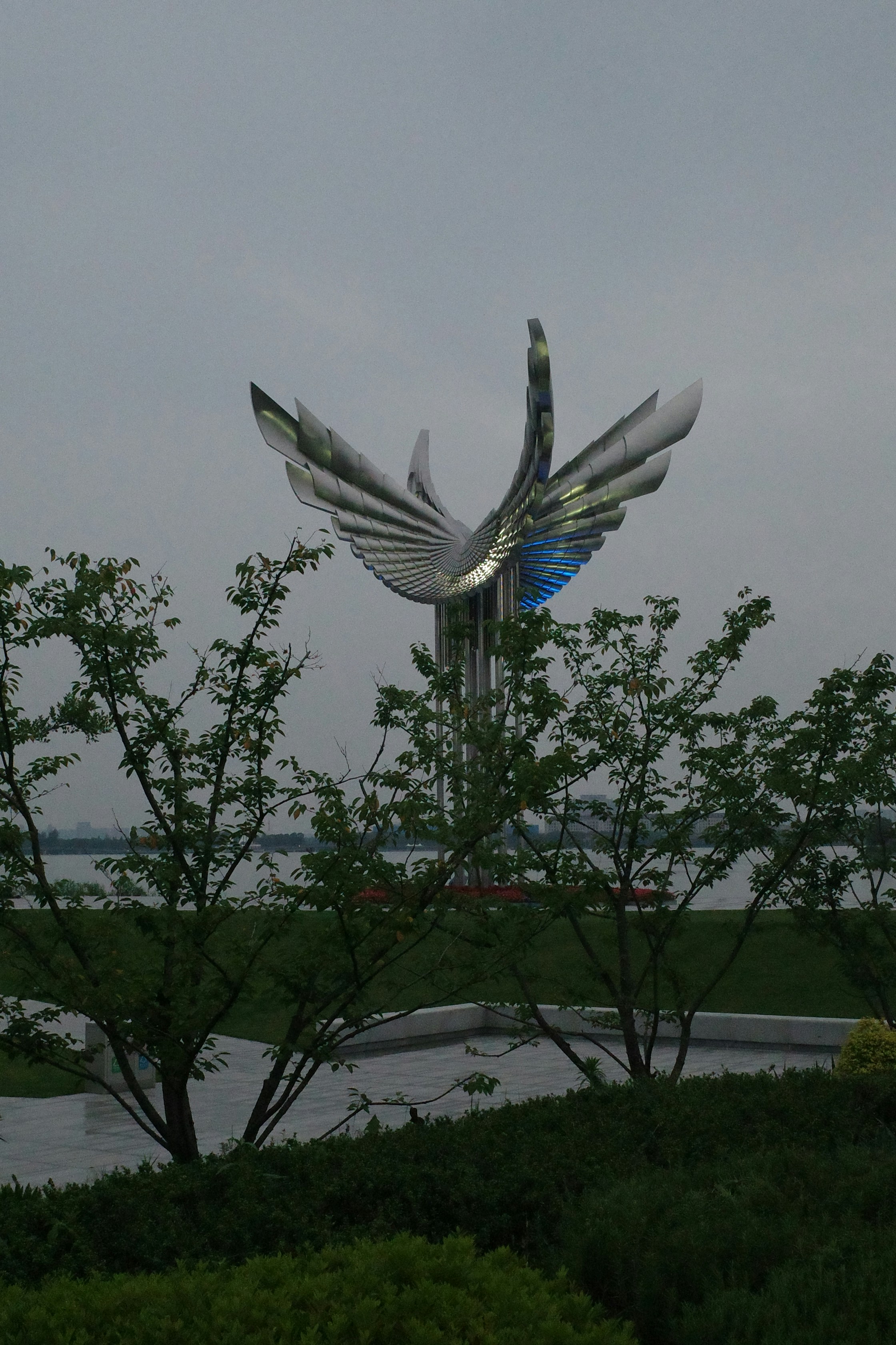 A large, metallic sculpture stands outdoors.