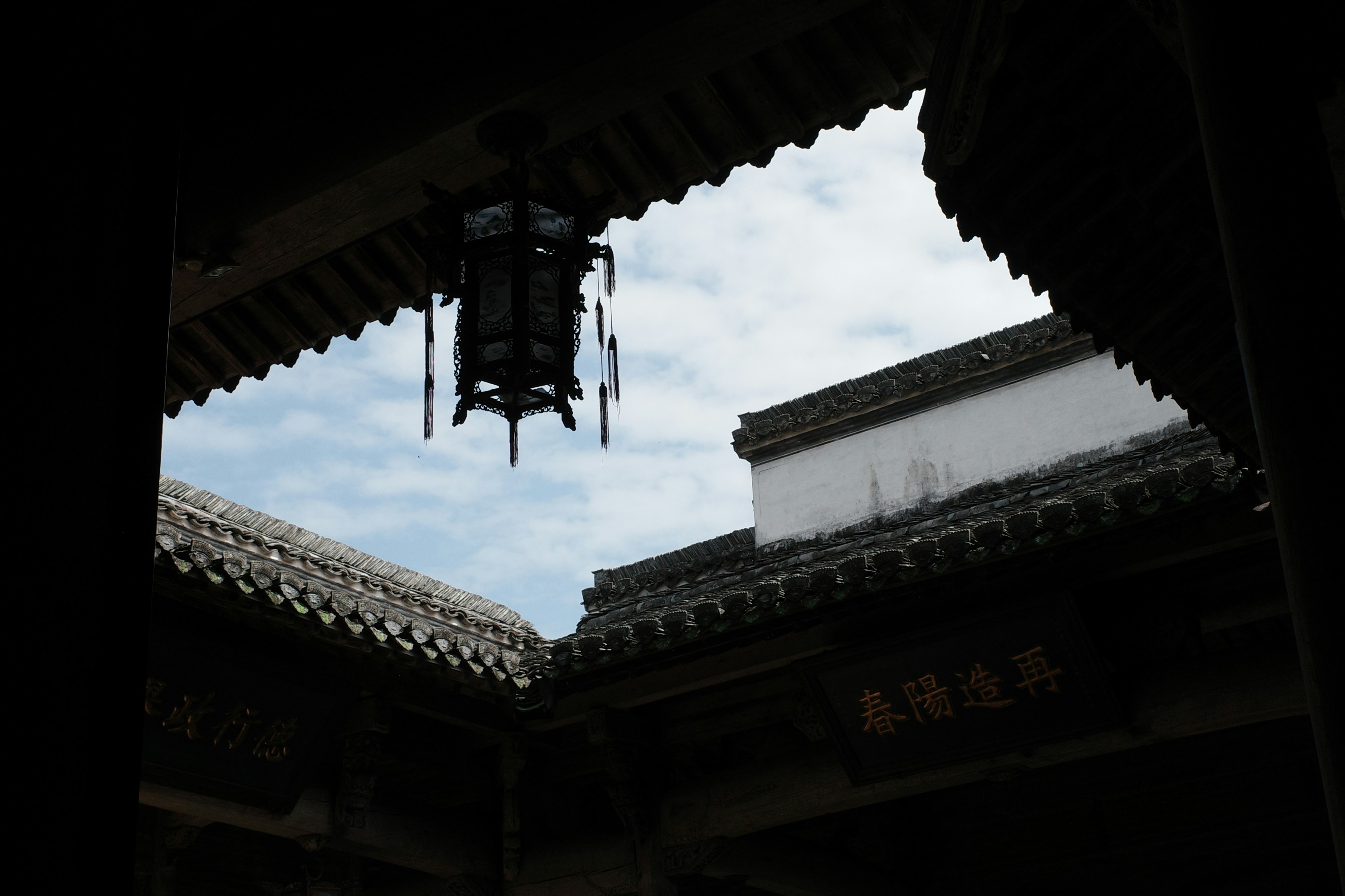 A lantern hangs in a traditional courtyard.