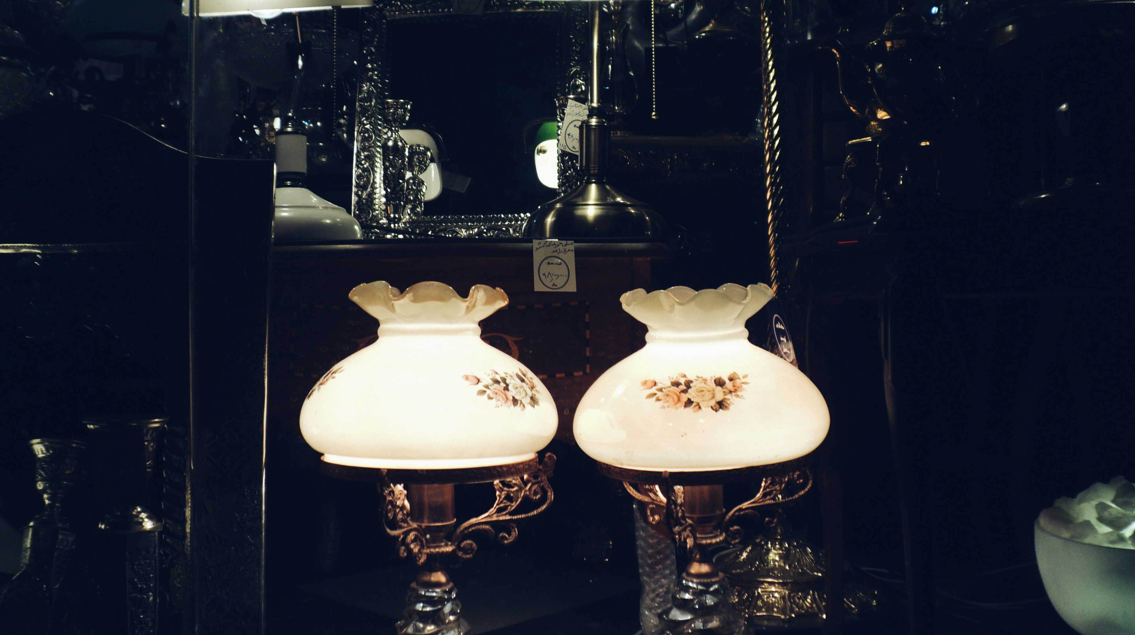 Illuminating memories. | Two decorative lamps hanging in a dark room.