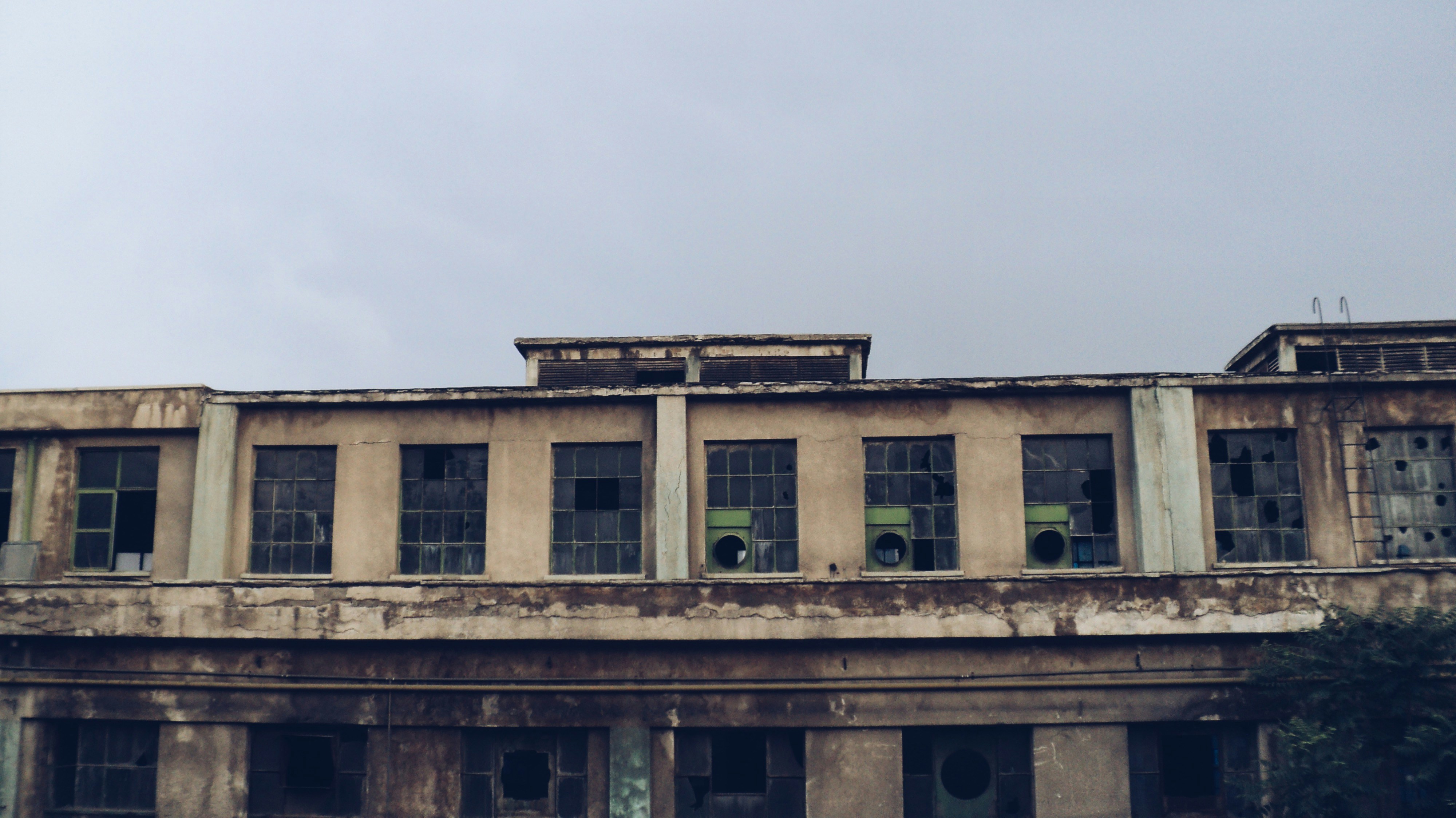 A symphony of broken glass. | Old, abandoned building with broken windows.