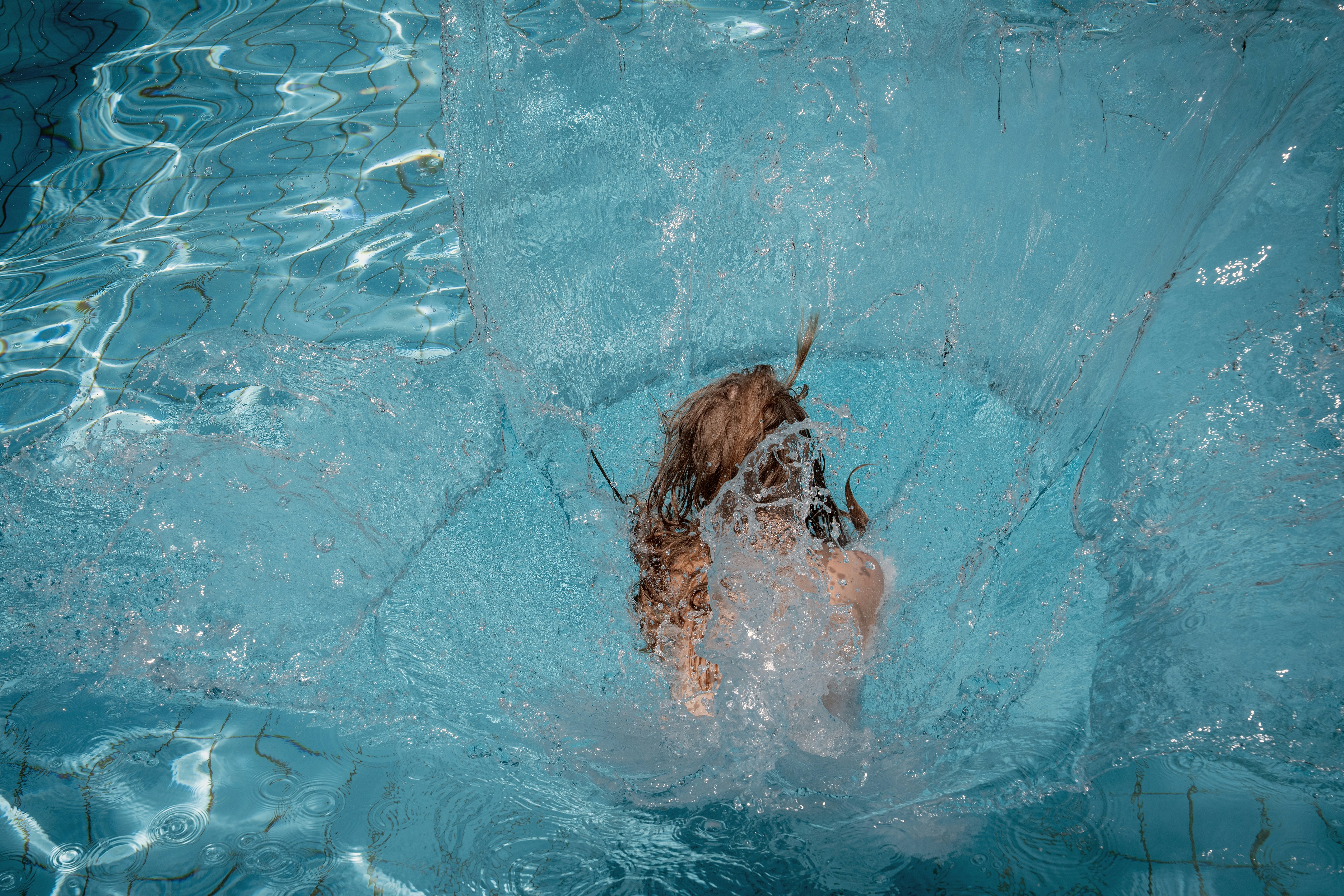 A person is diving into a swimming pool.