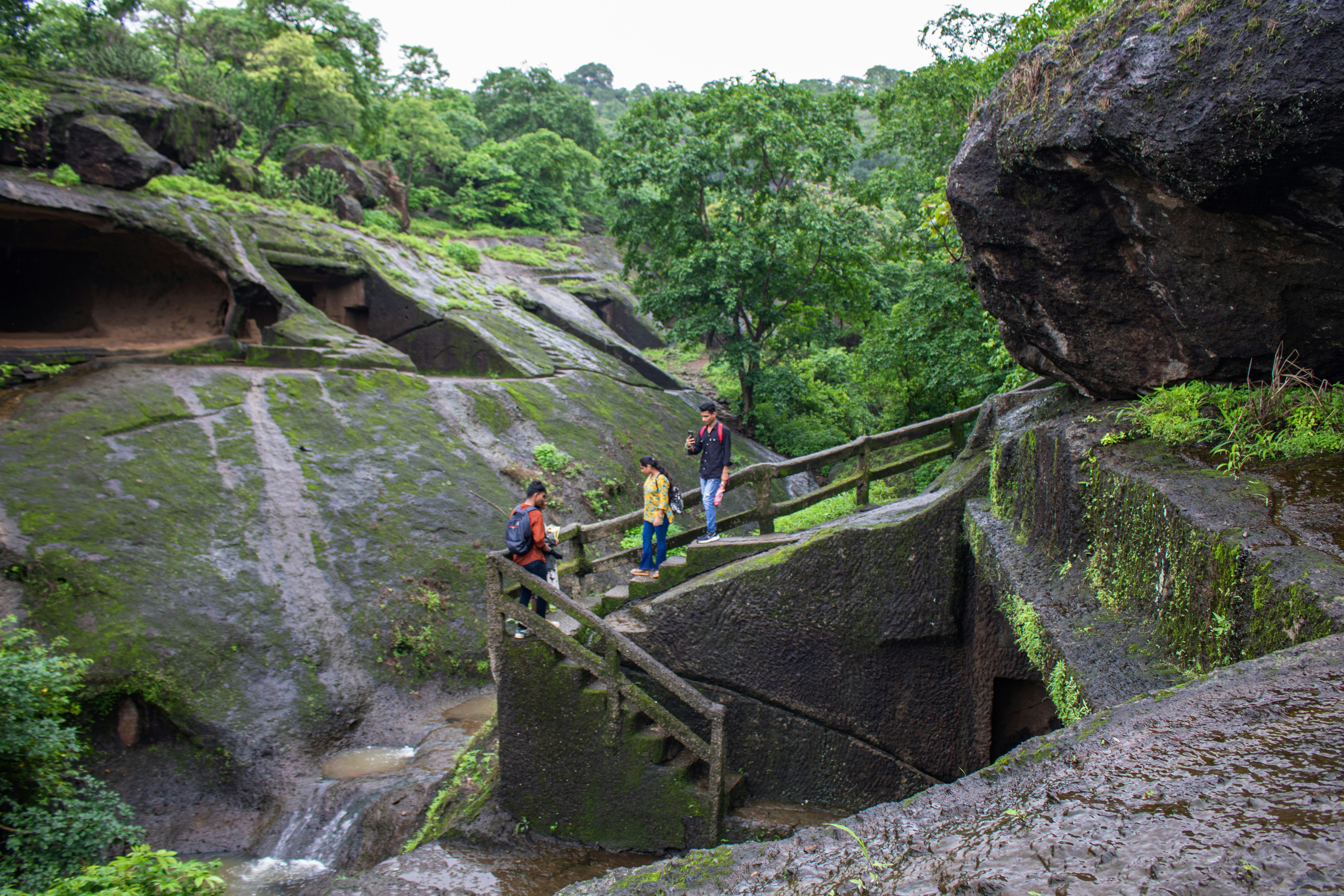 Cliffside Facade: Family Trek Across mossy stone shelves