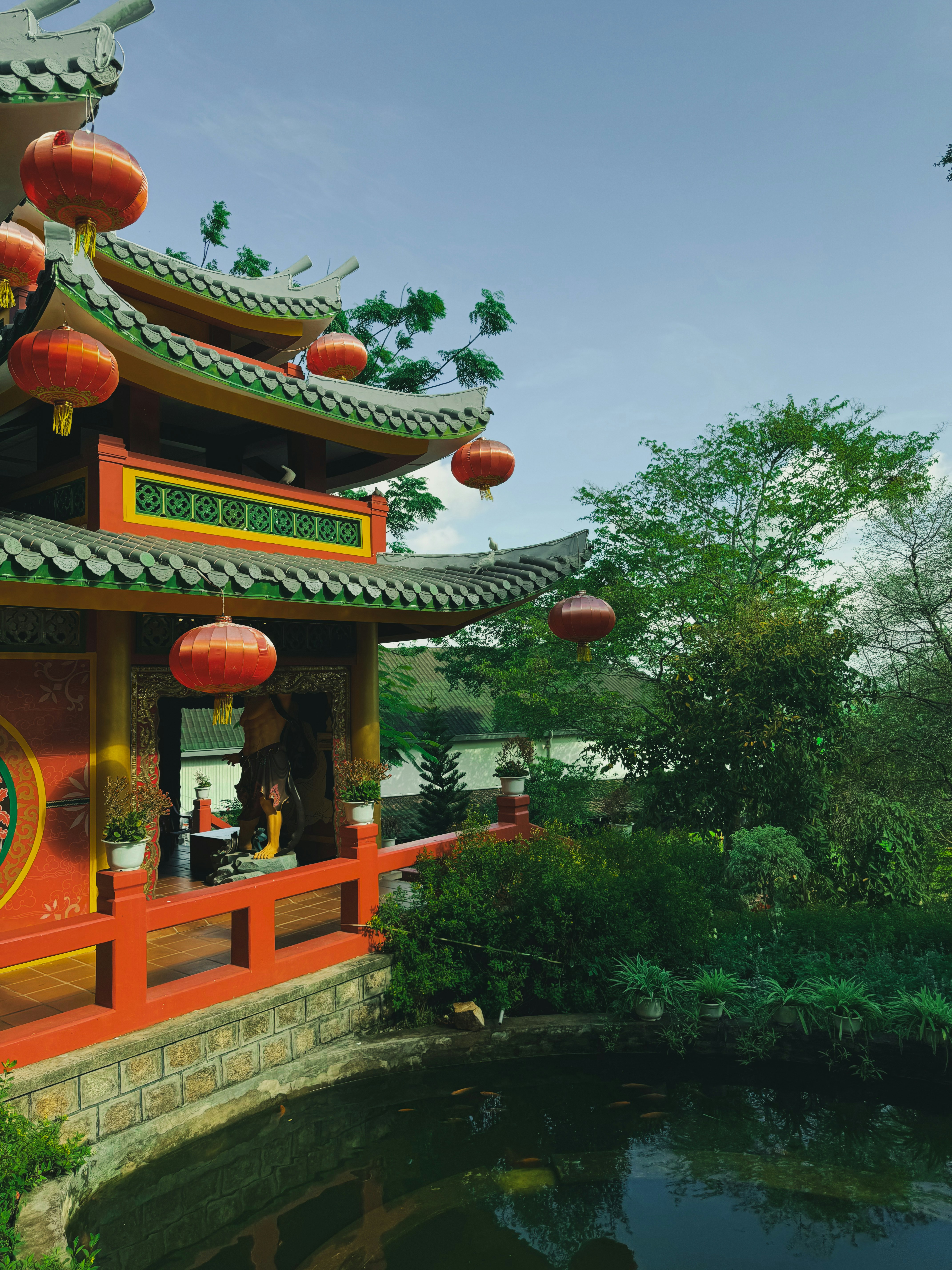 Phật Ngọc Temple | A colorful temple stands beside a peaceful pond.