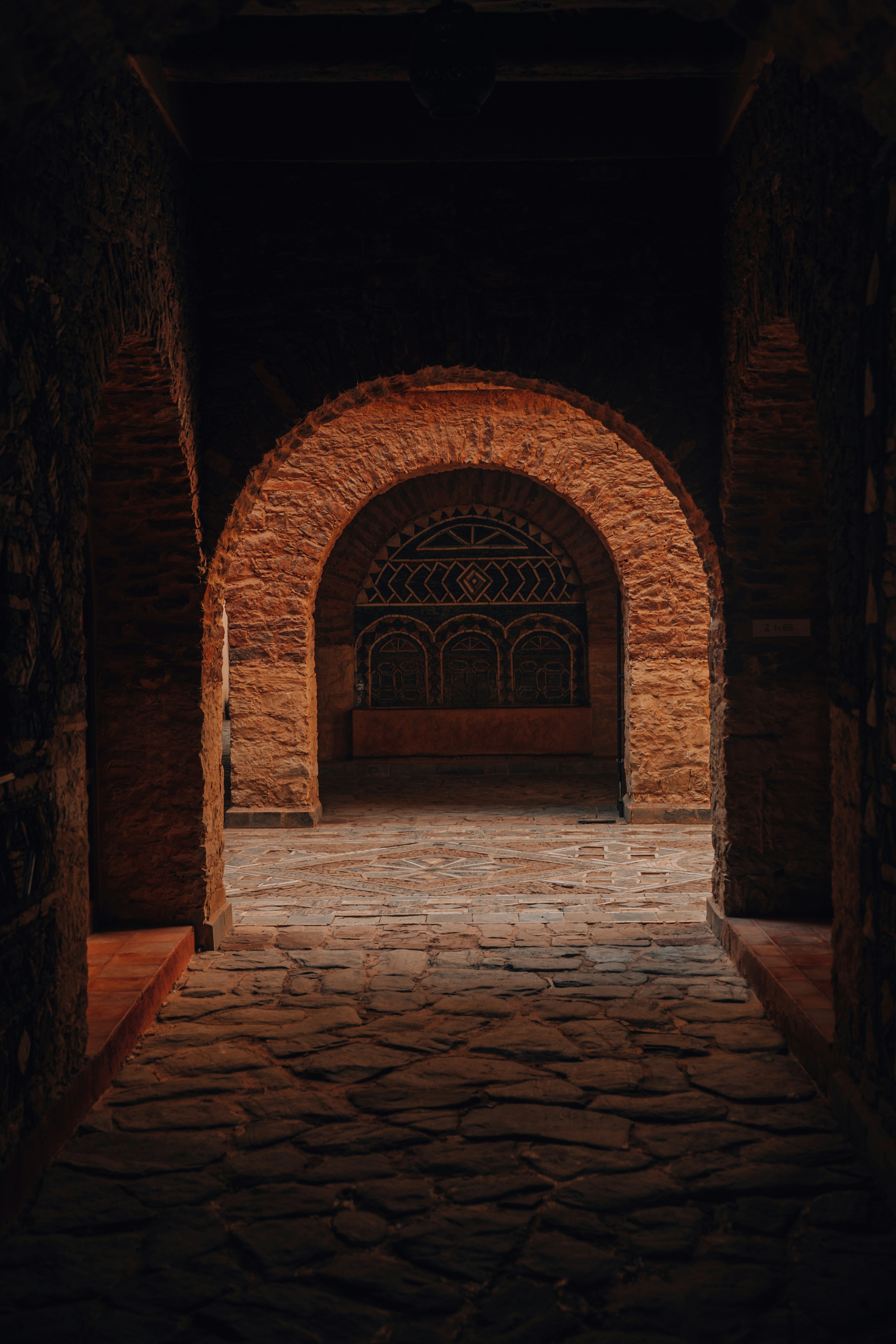 Arches frame the path of a brick structure.