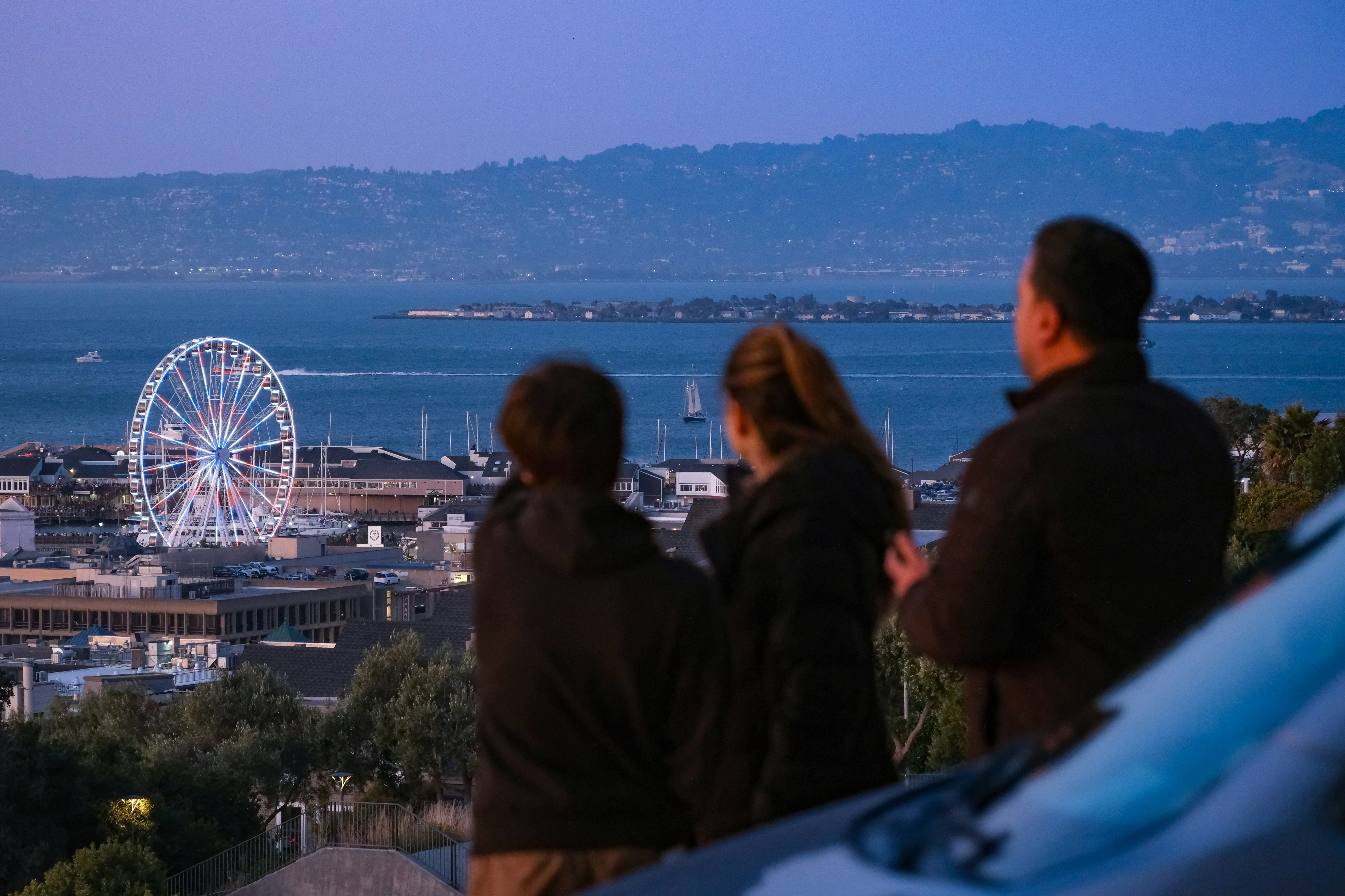 Cityscape Gaze: Ferris Wheel Edge and silhouettes at twilight
