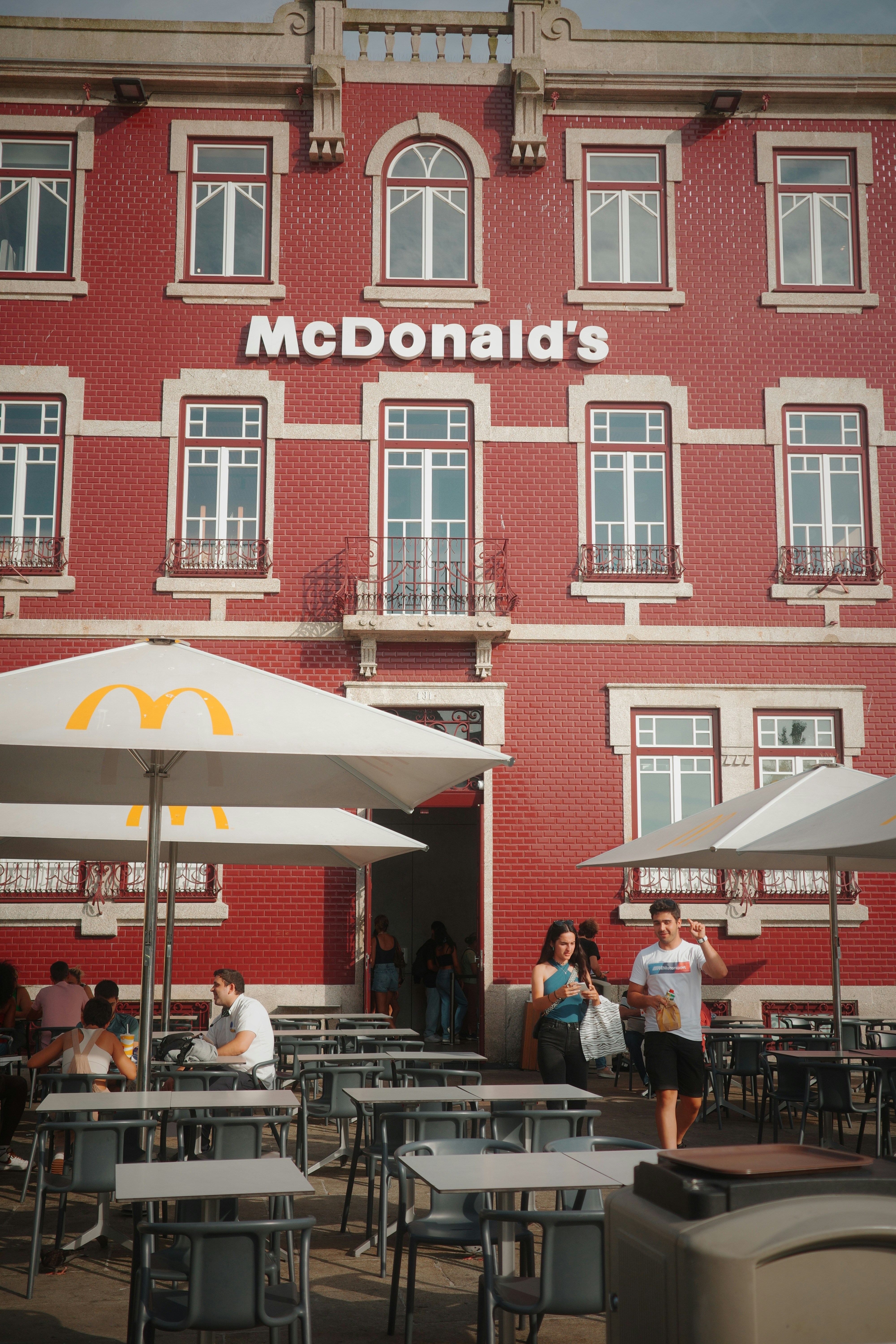 A mcdonald's restaurant in a unique red building.