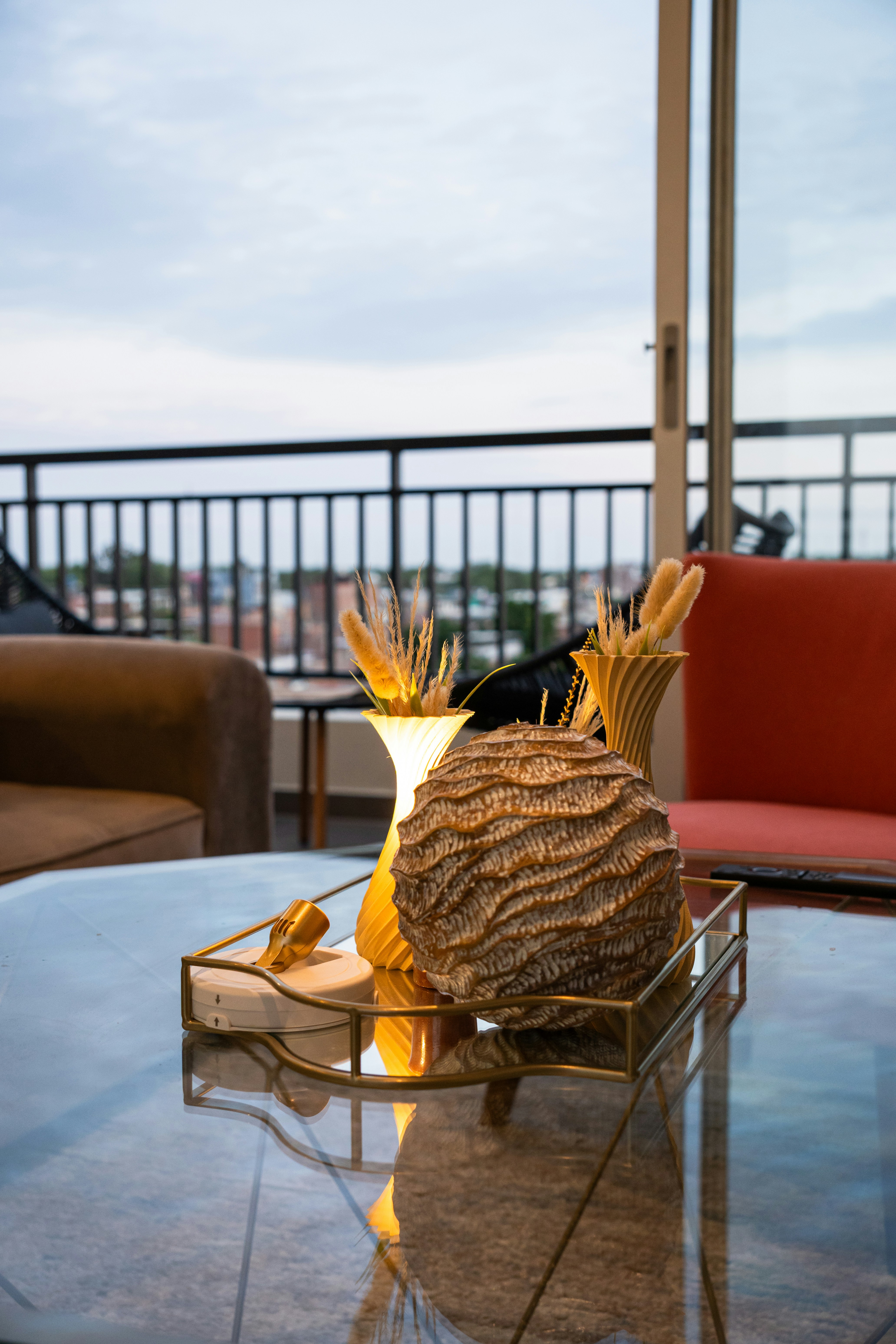 Decorative objects rest on a glass table.
