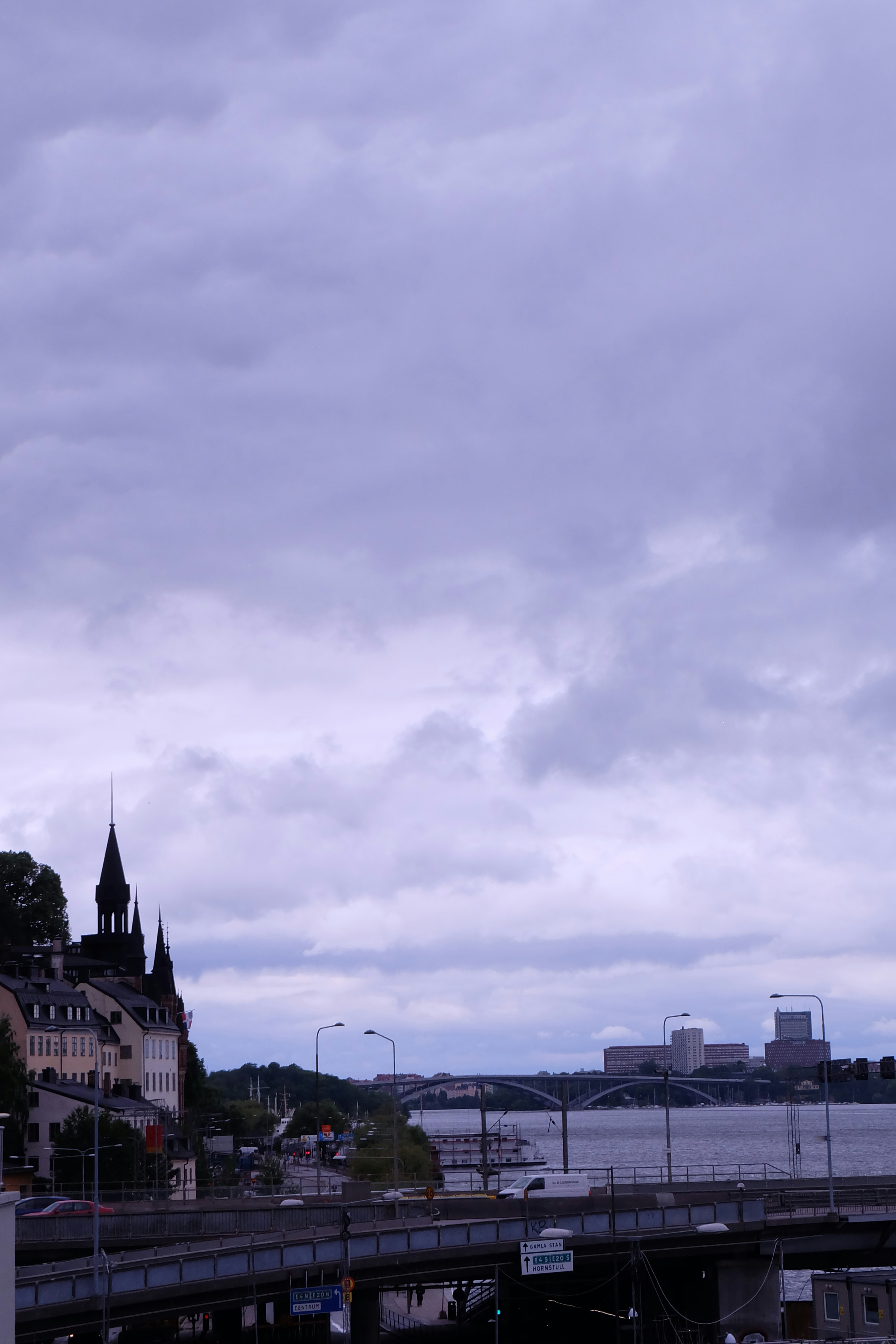 Whispers of the River: A City Embraced by Clouds