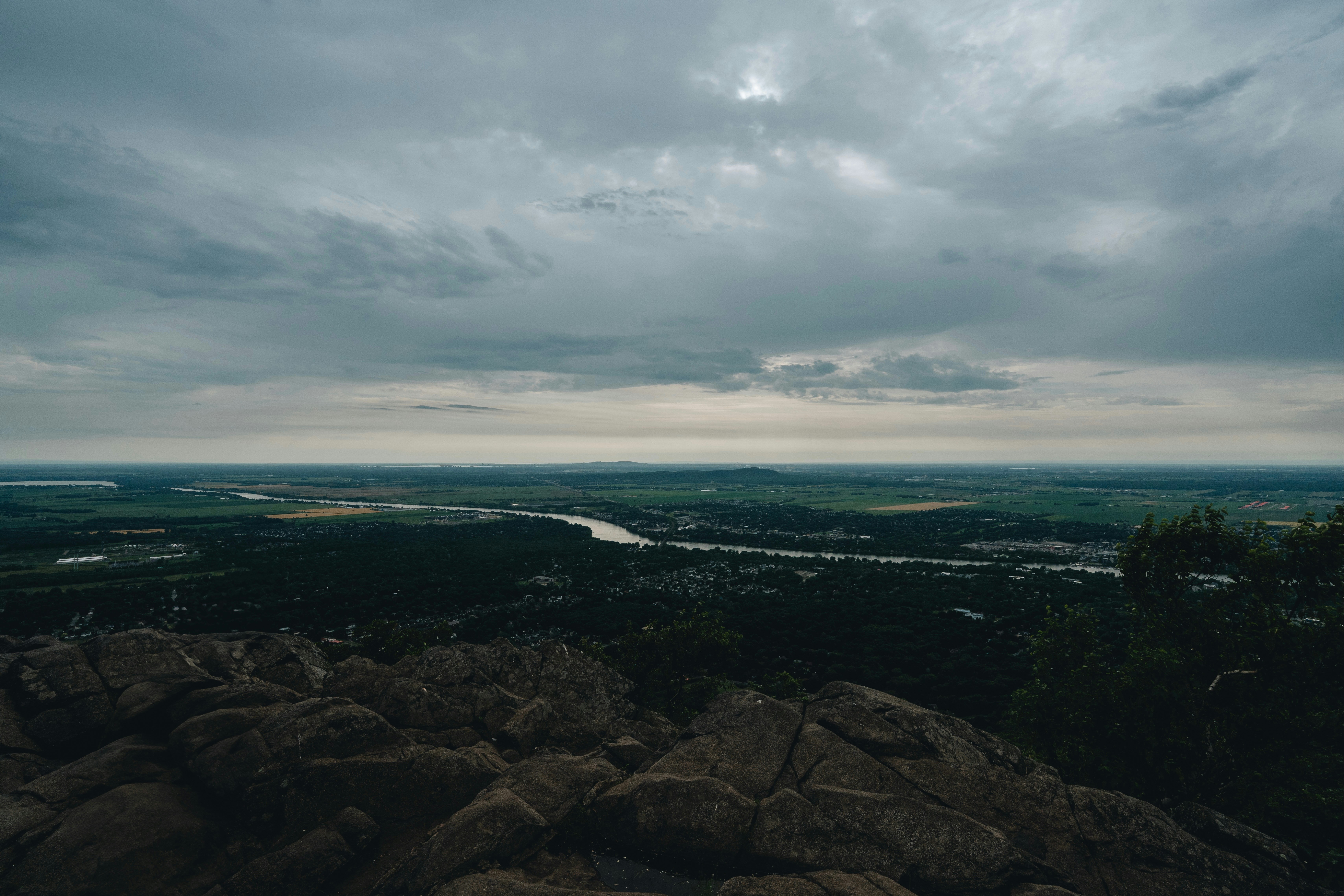 Overcast sky blankets the distant, expansive landscape.