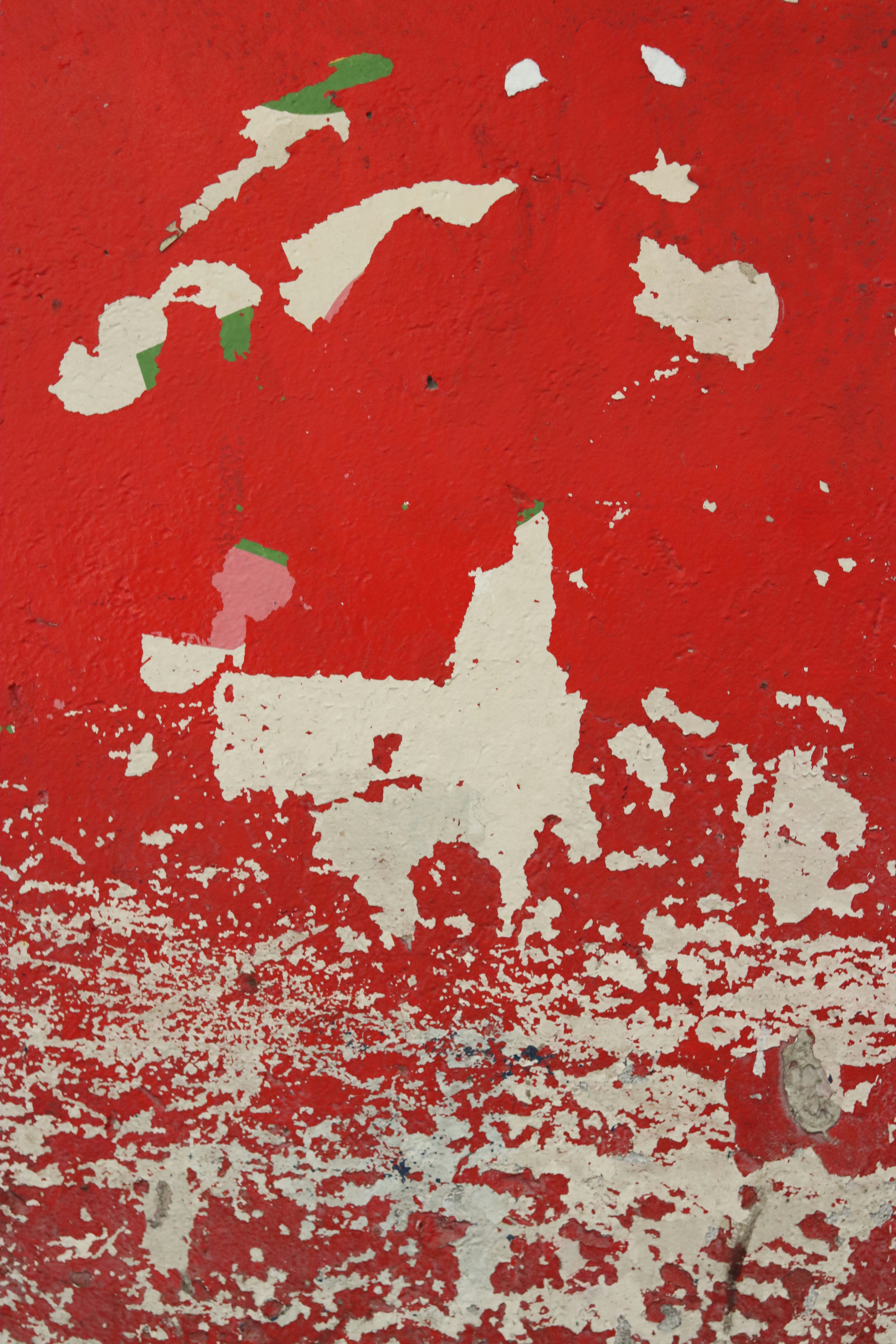Crimson Strata: Timeworn Paint Layers on a Weathered Wall
