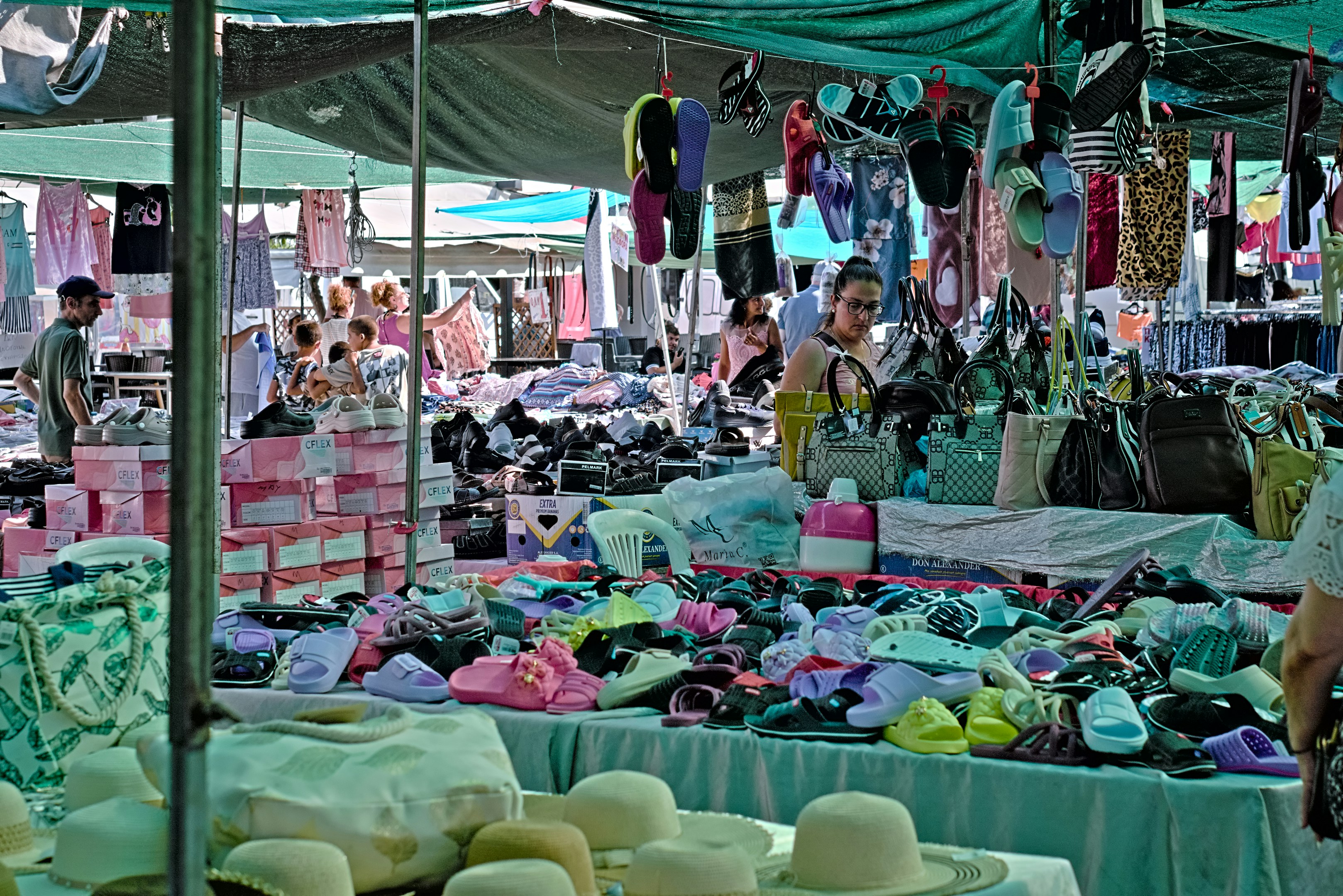 A bustling market stall offers various items for sale.