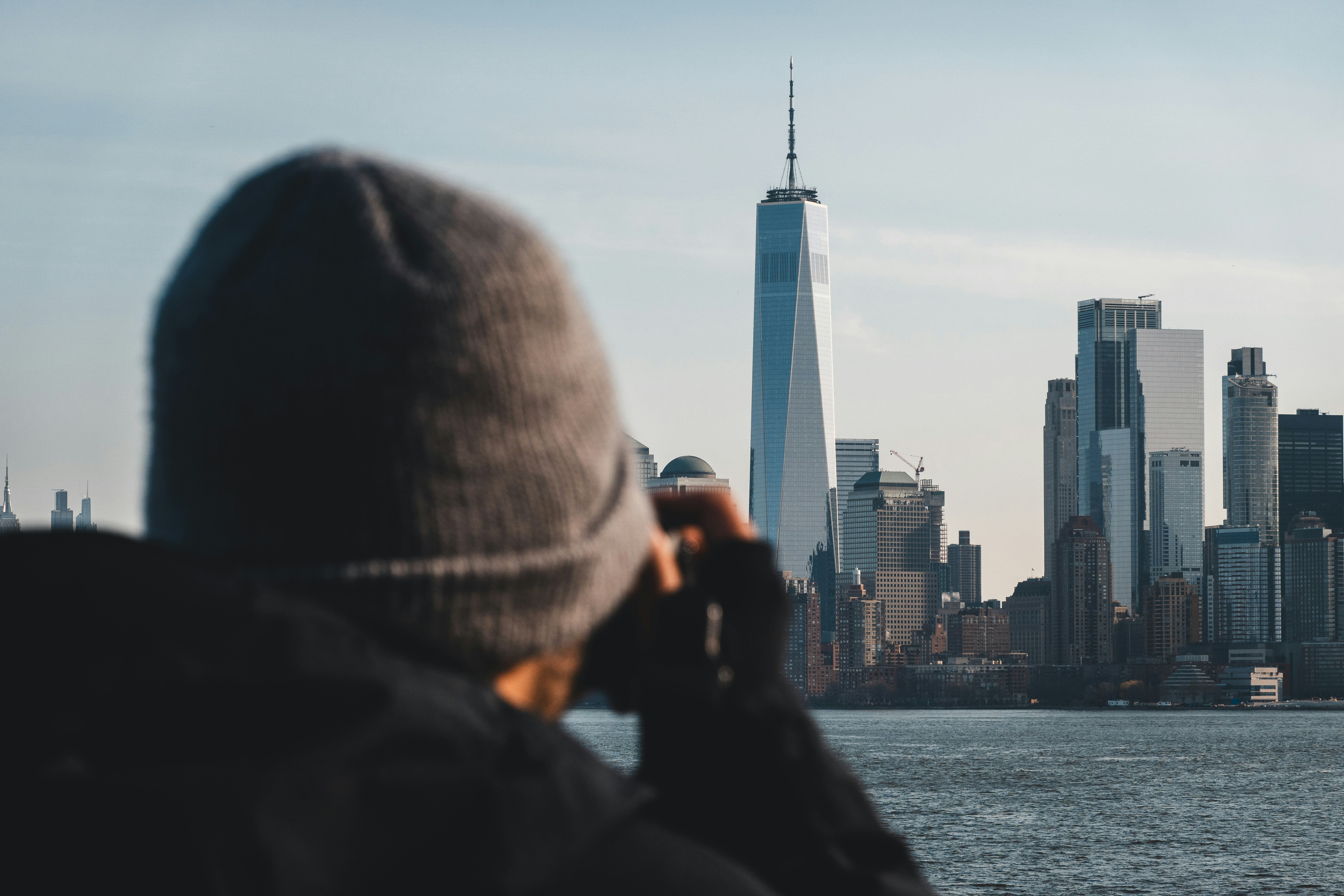 Person looks at a city skyline with tall buildings.