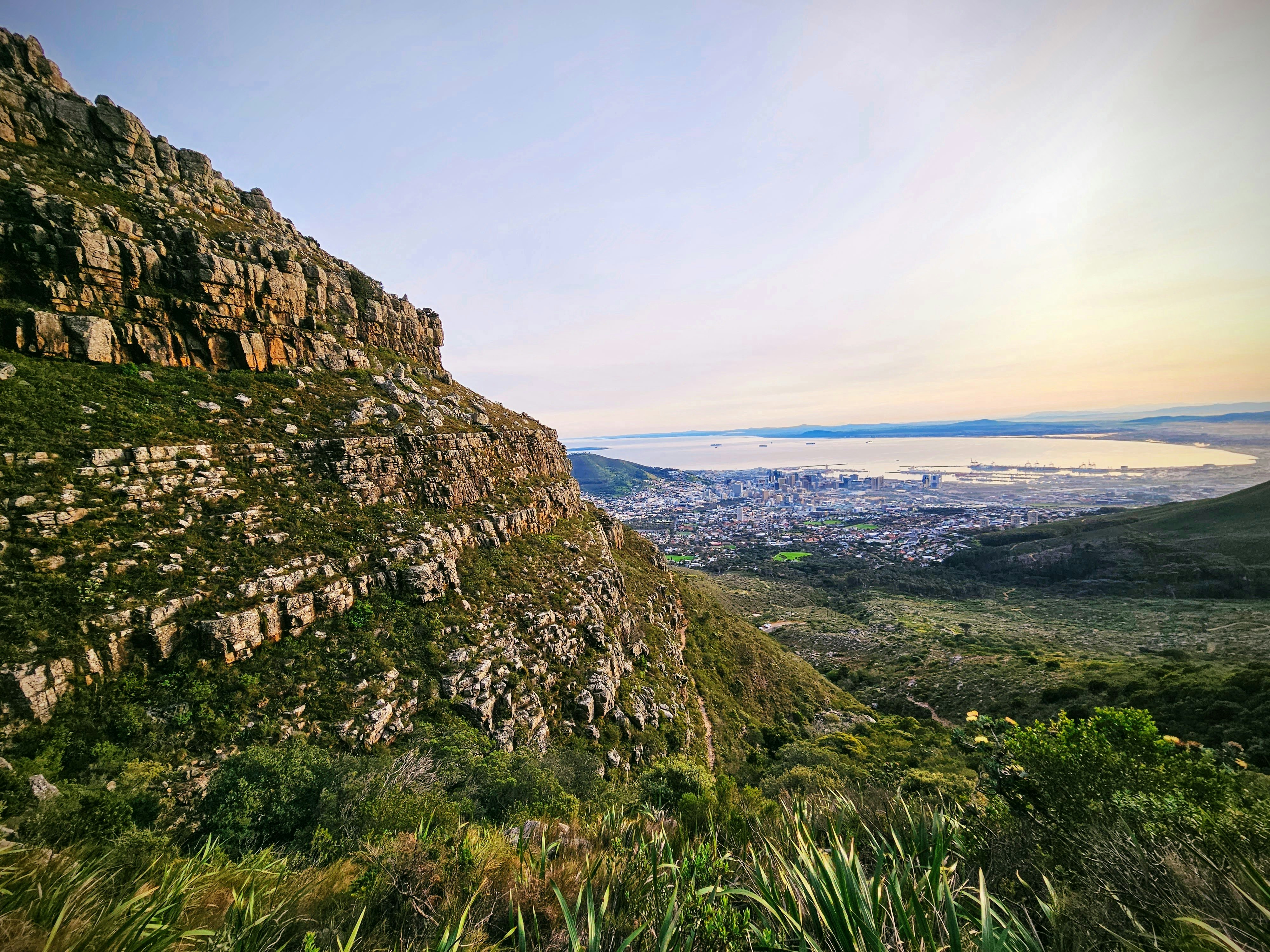 Mountain view overlooking a city and water.