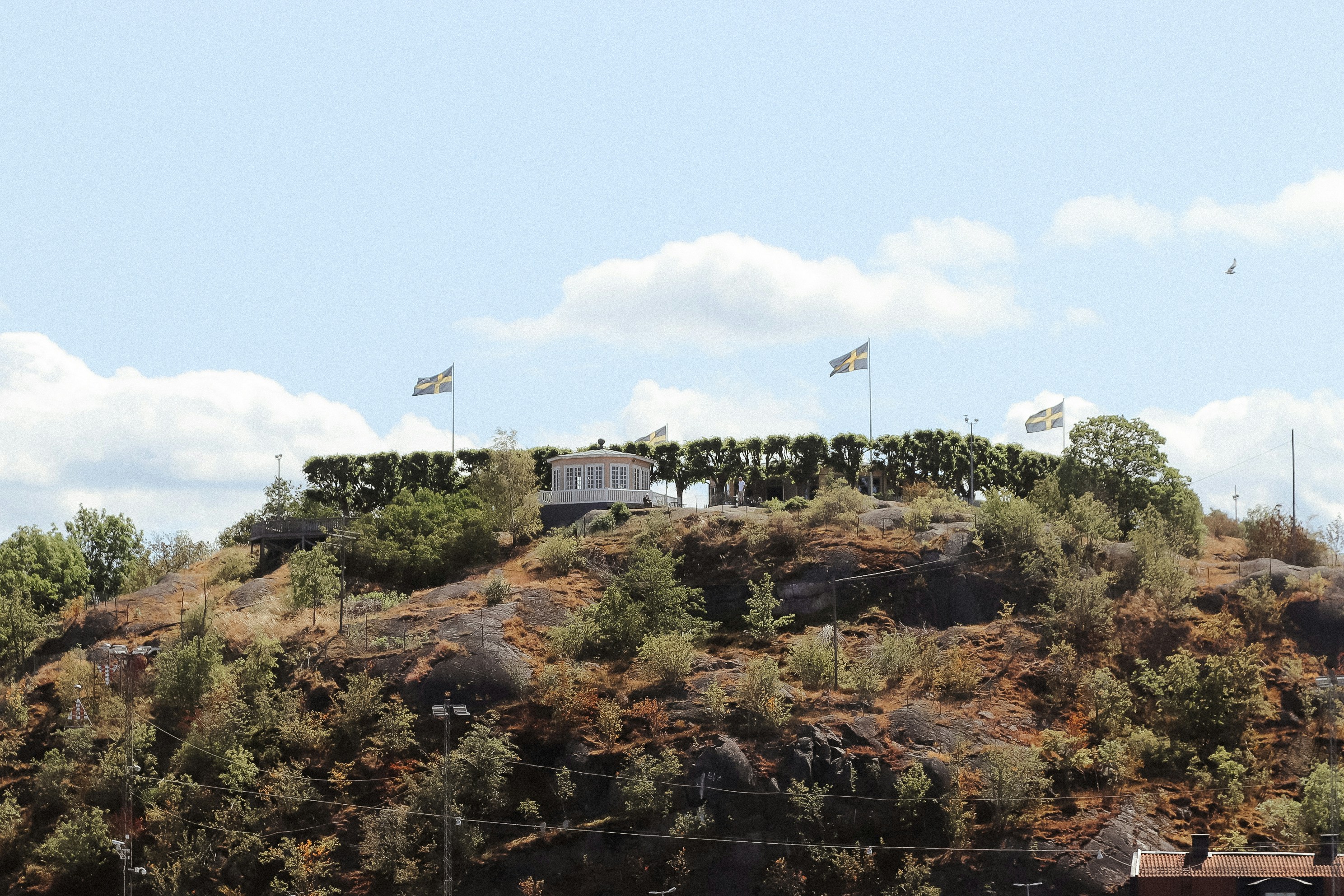 A hilltop structure with flags.