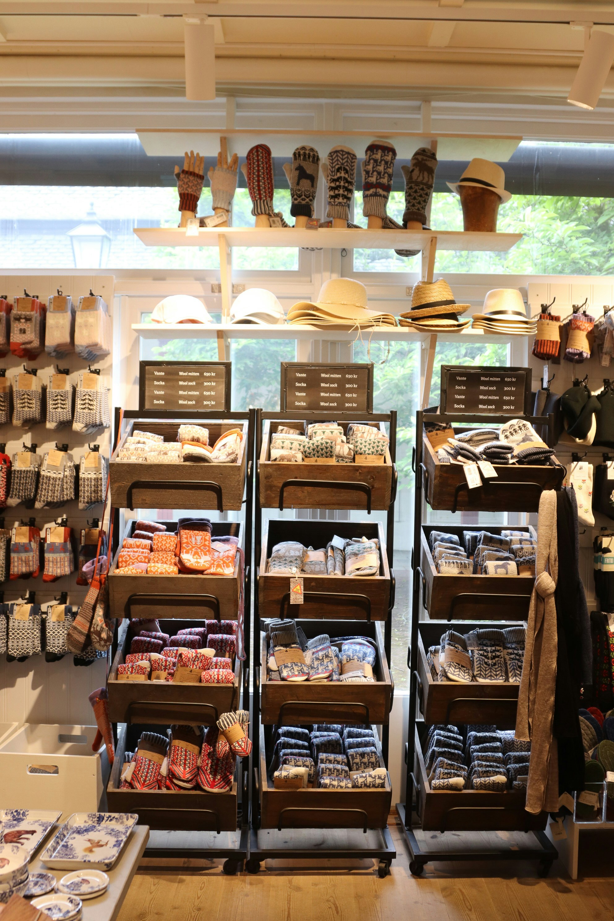 Rows of Knitwear: Hats, Socks, and Scarves in a Sunny Shop