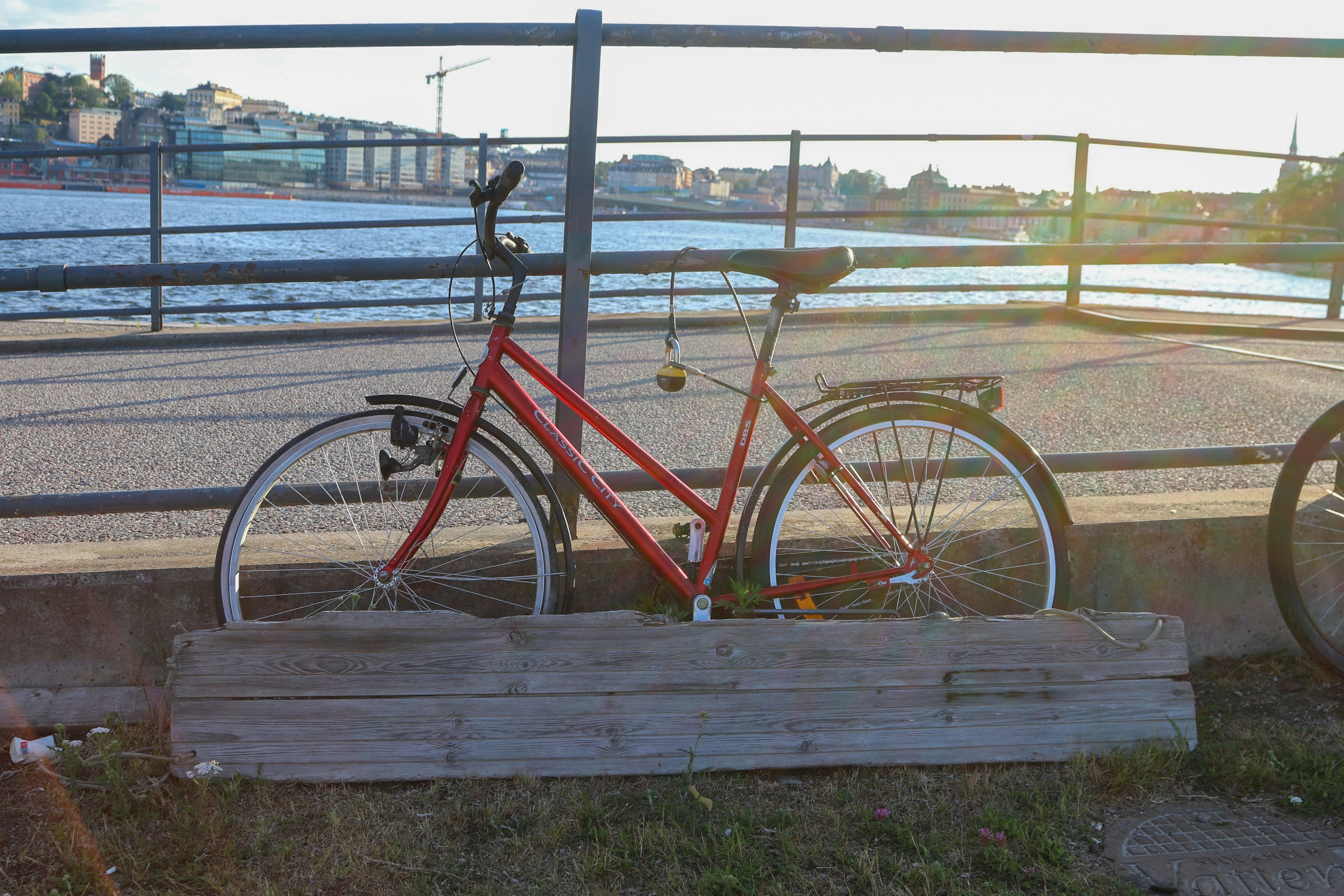 Red Bicycle by the Waterfront: Quiet Tug of City Light