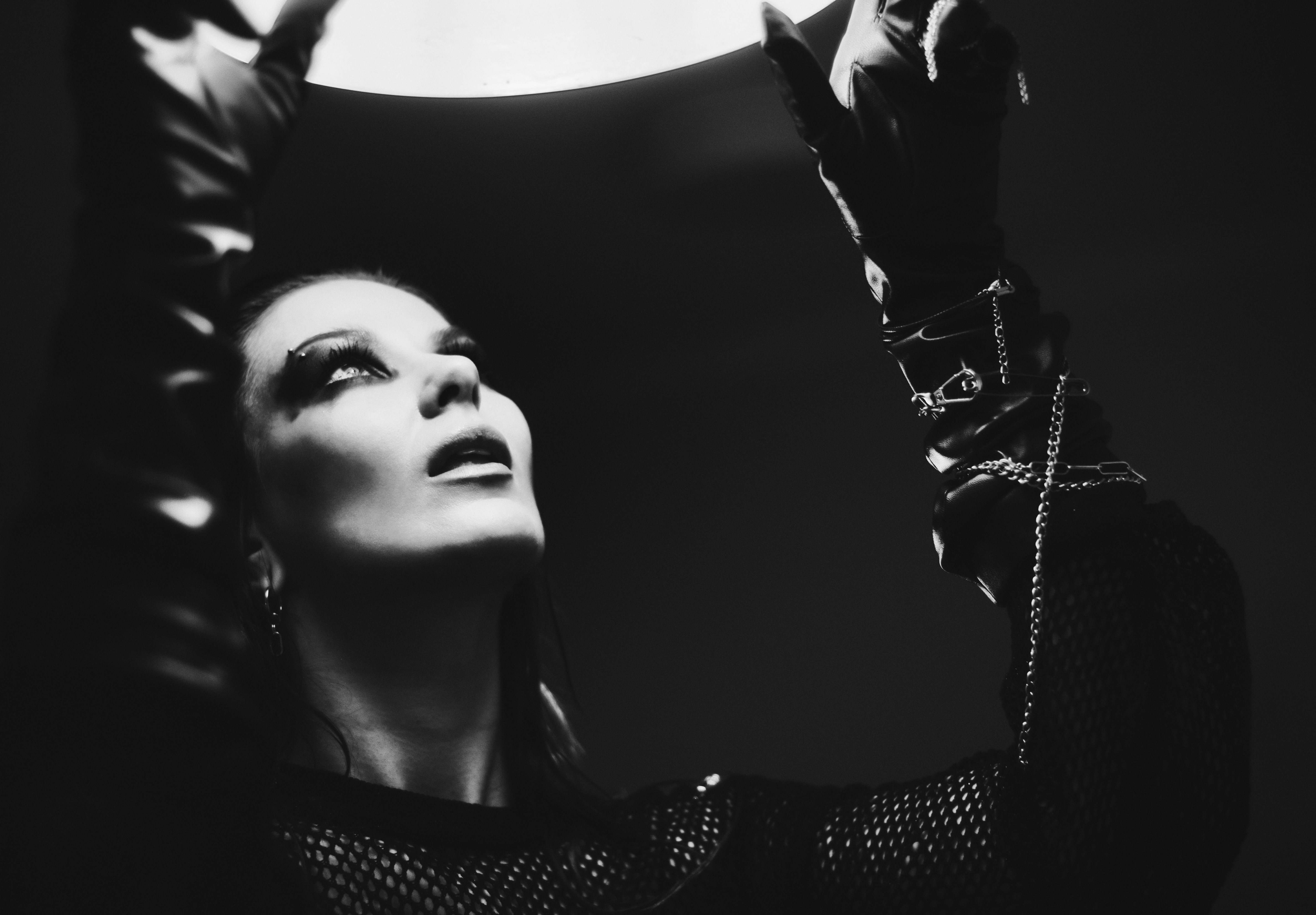 Crescent Glow: A Noir Fashion Portrait of Gaze and Gloved Hands