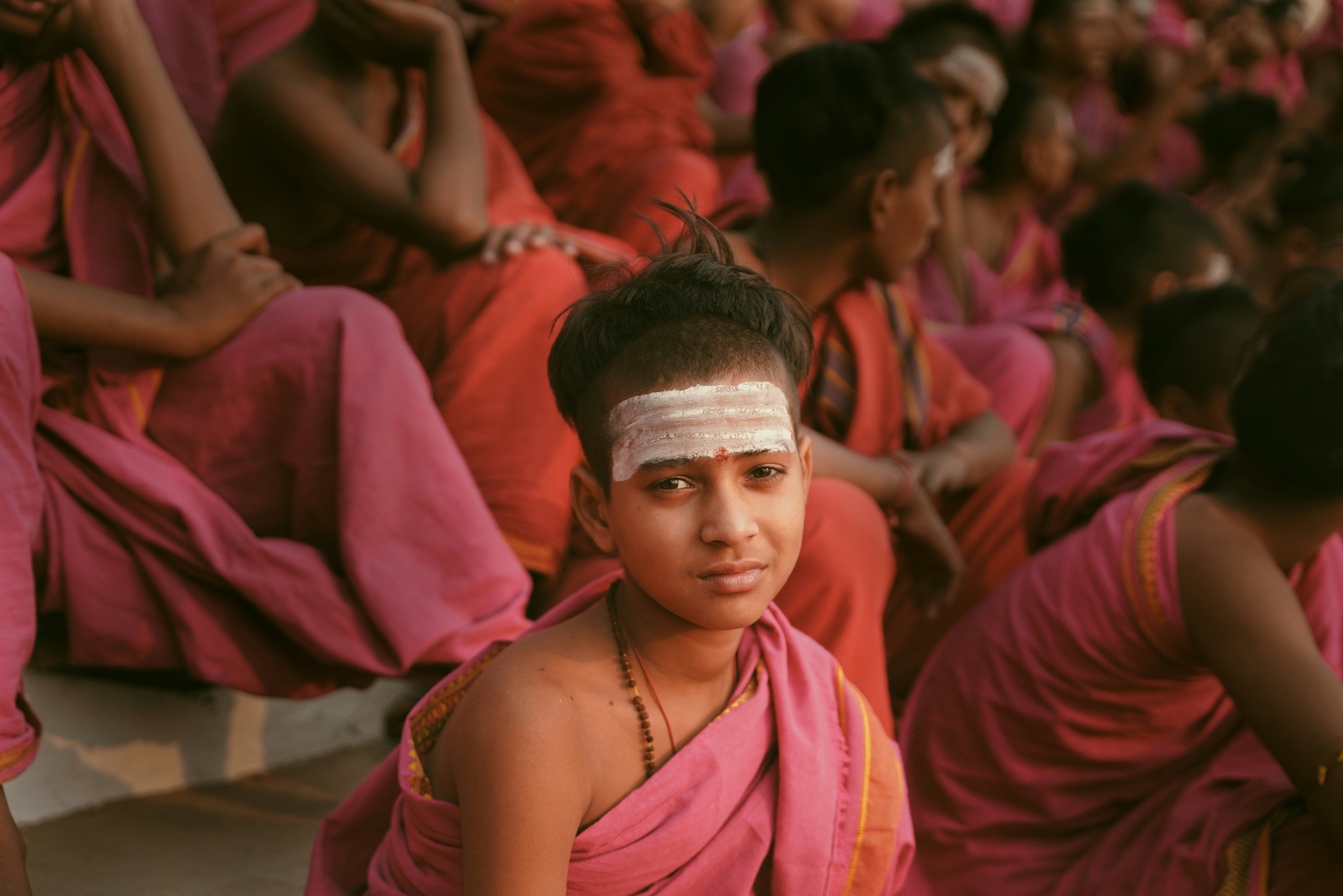 At the ghats of Varanasi. Morning Raagas | People in robes are sitting together in a crowd.