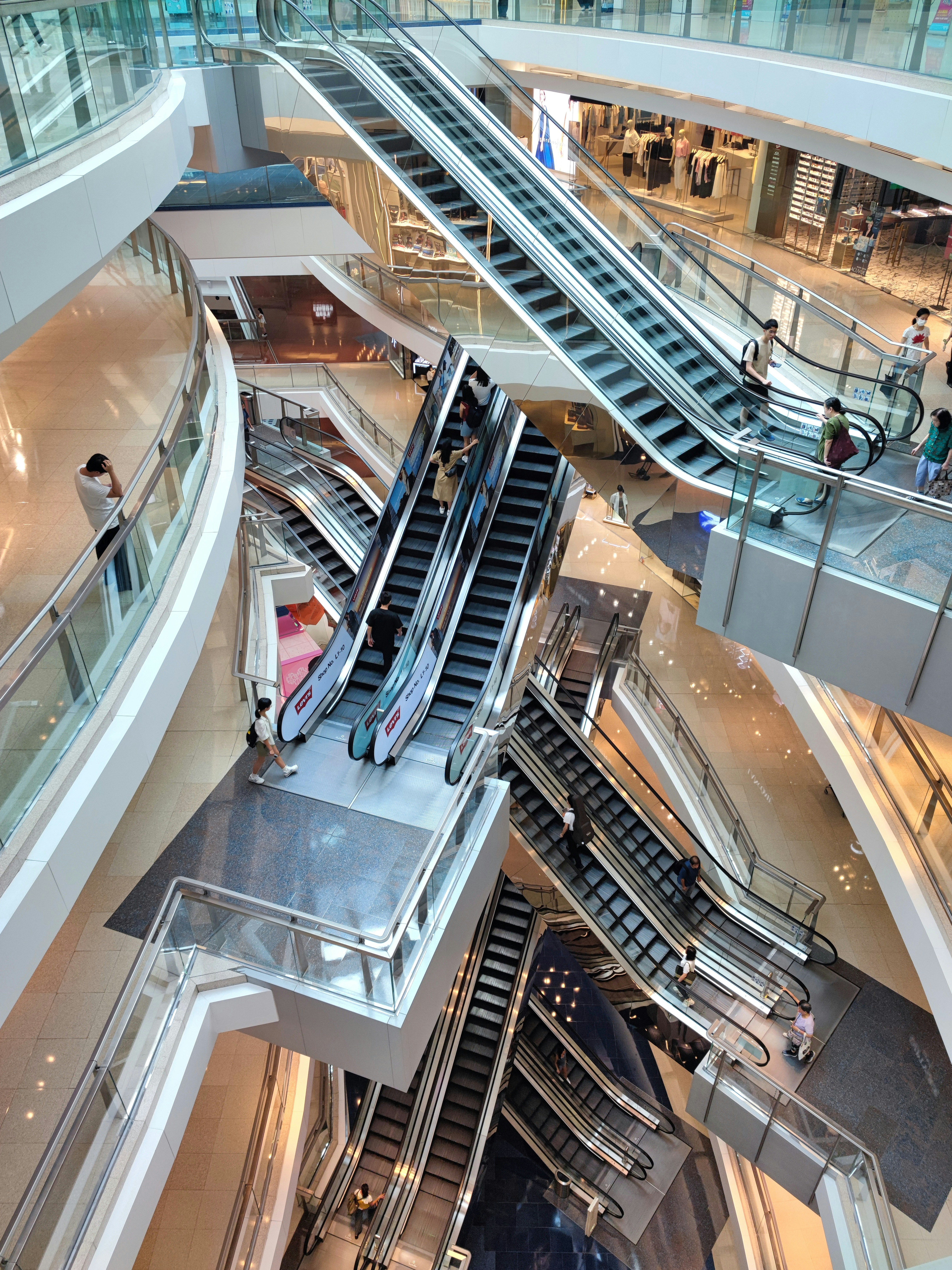 Escalators fill a modern, multi-level shopping mall. photo – Free ...