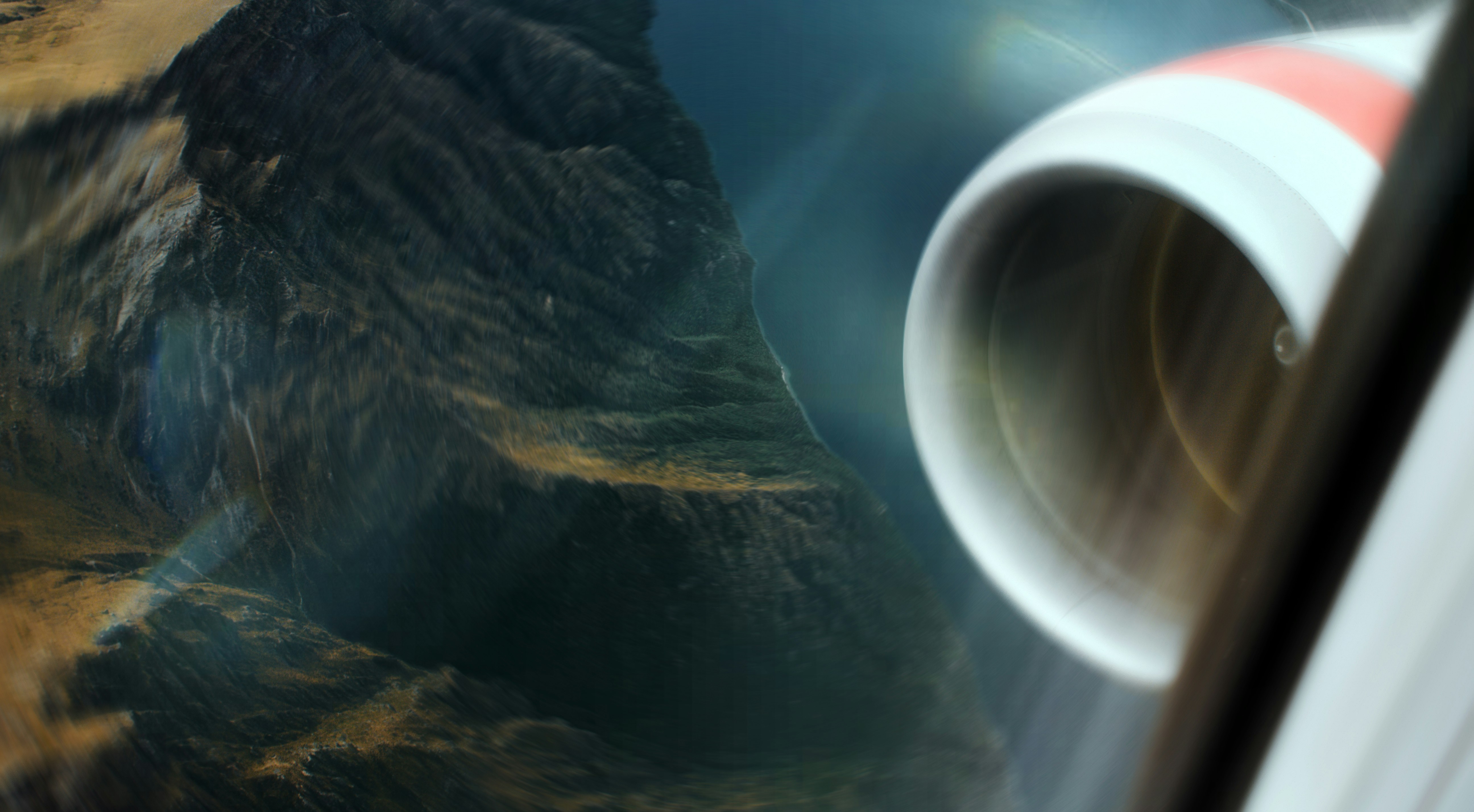 Jet Engine Window Vista: Mountain Reflections Beyond the Turbine