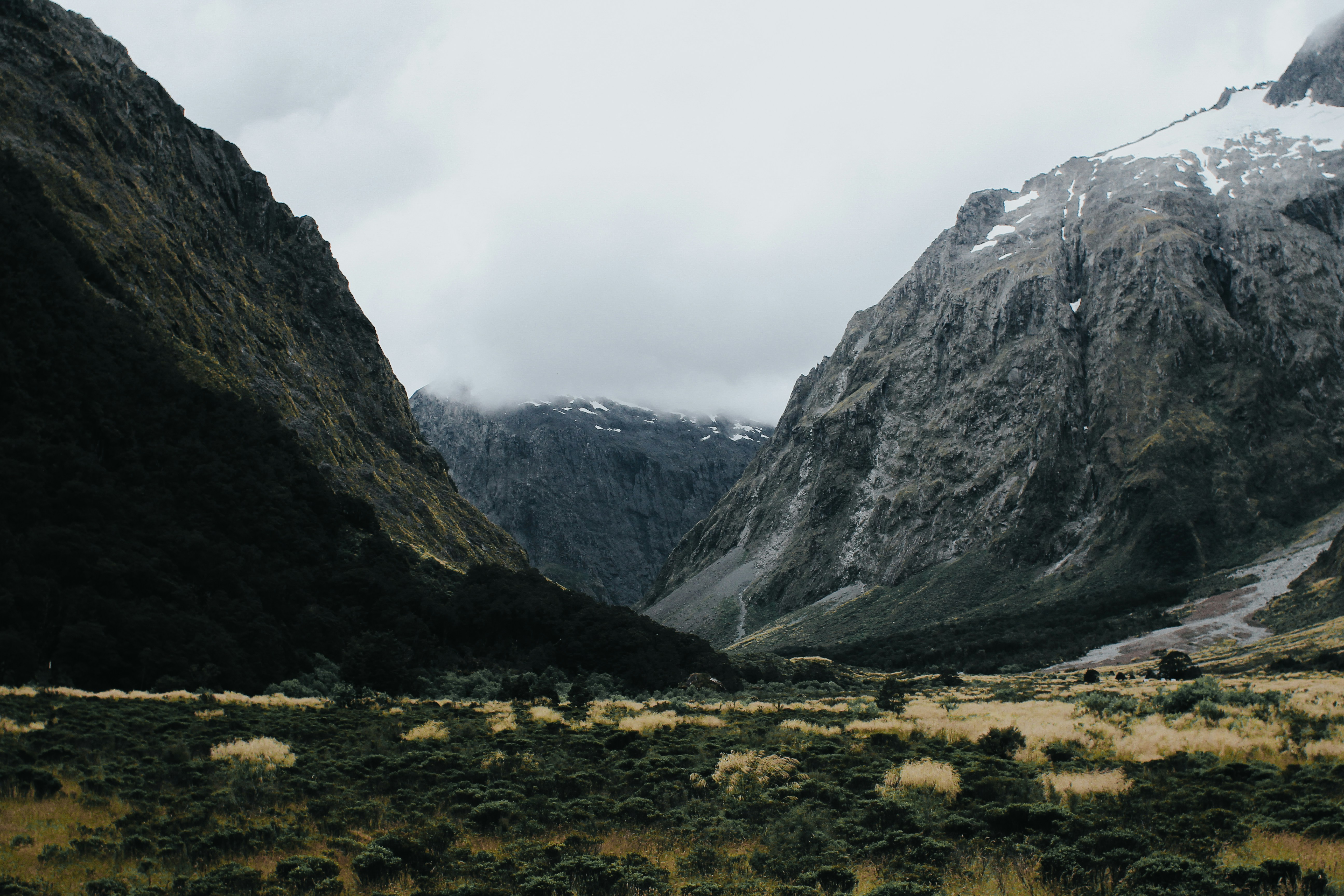 Mountains rise up through the overcast sky.