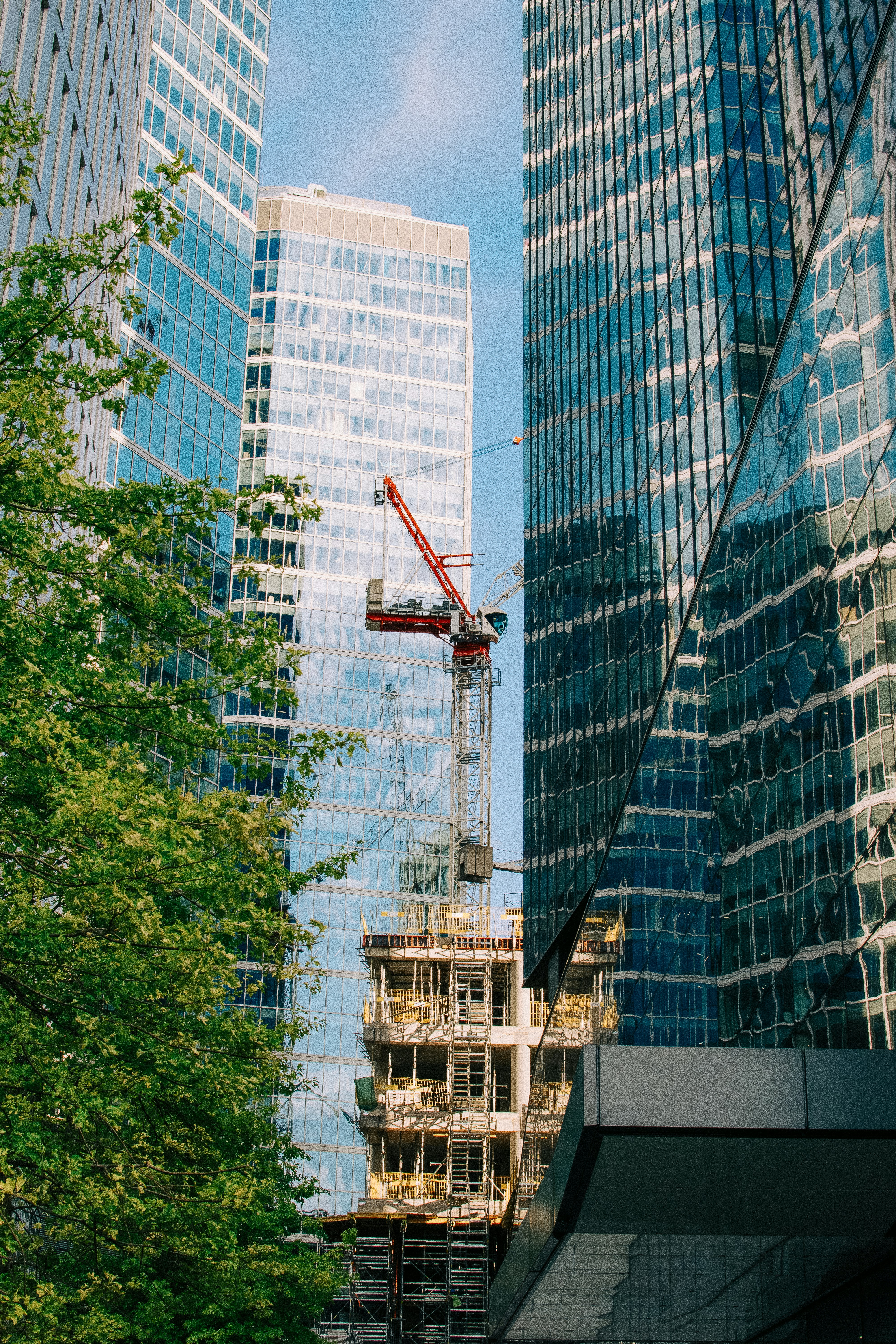 Construction is underway between tall, modern buildings.