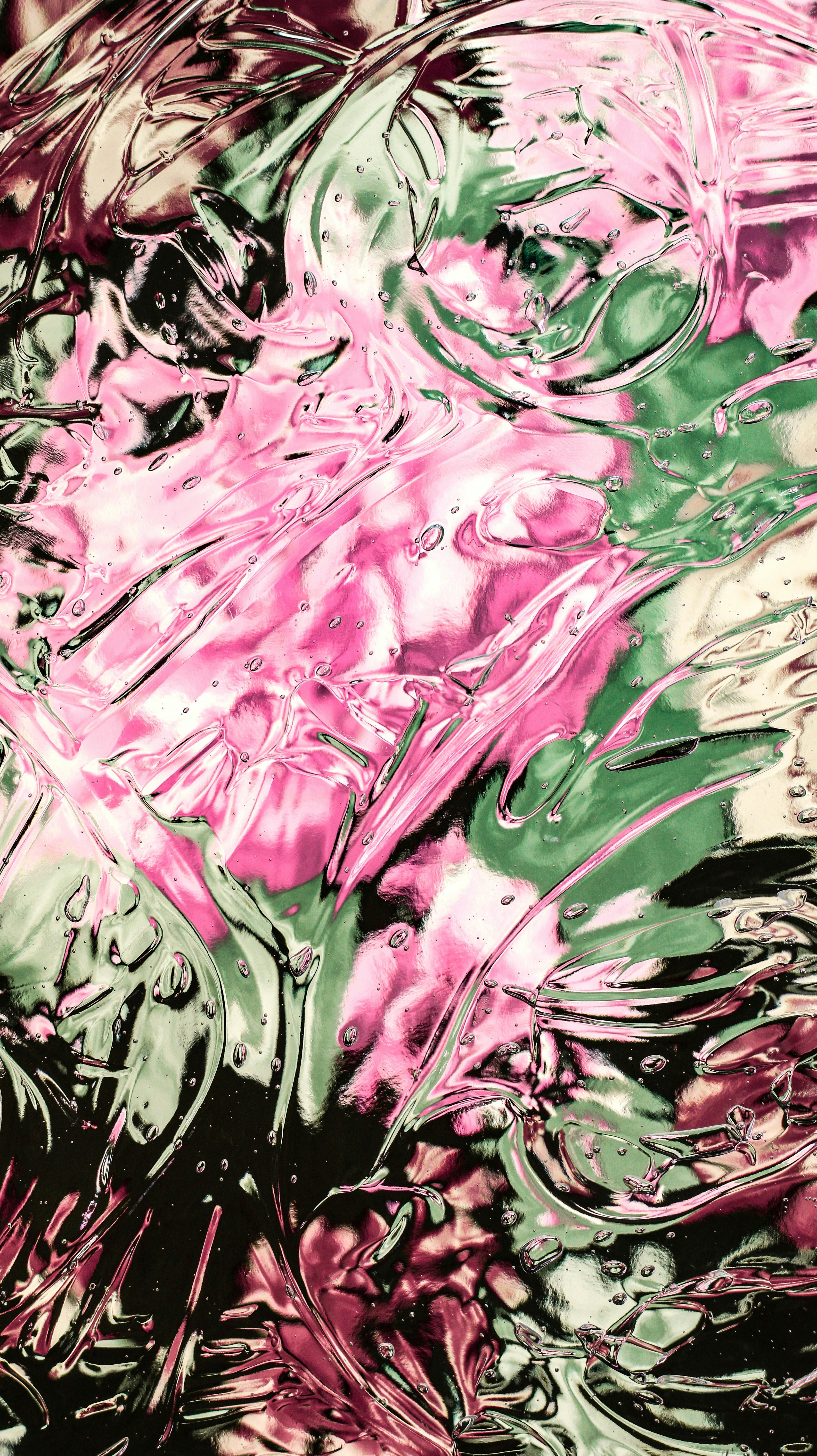 Abstract art with pink, green, and clear textures.