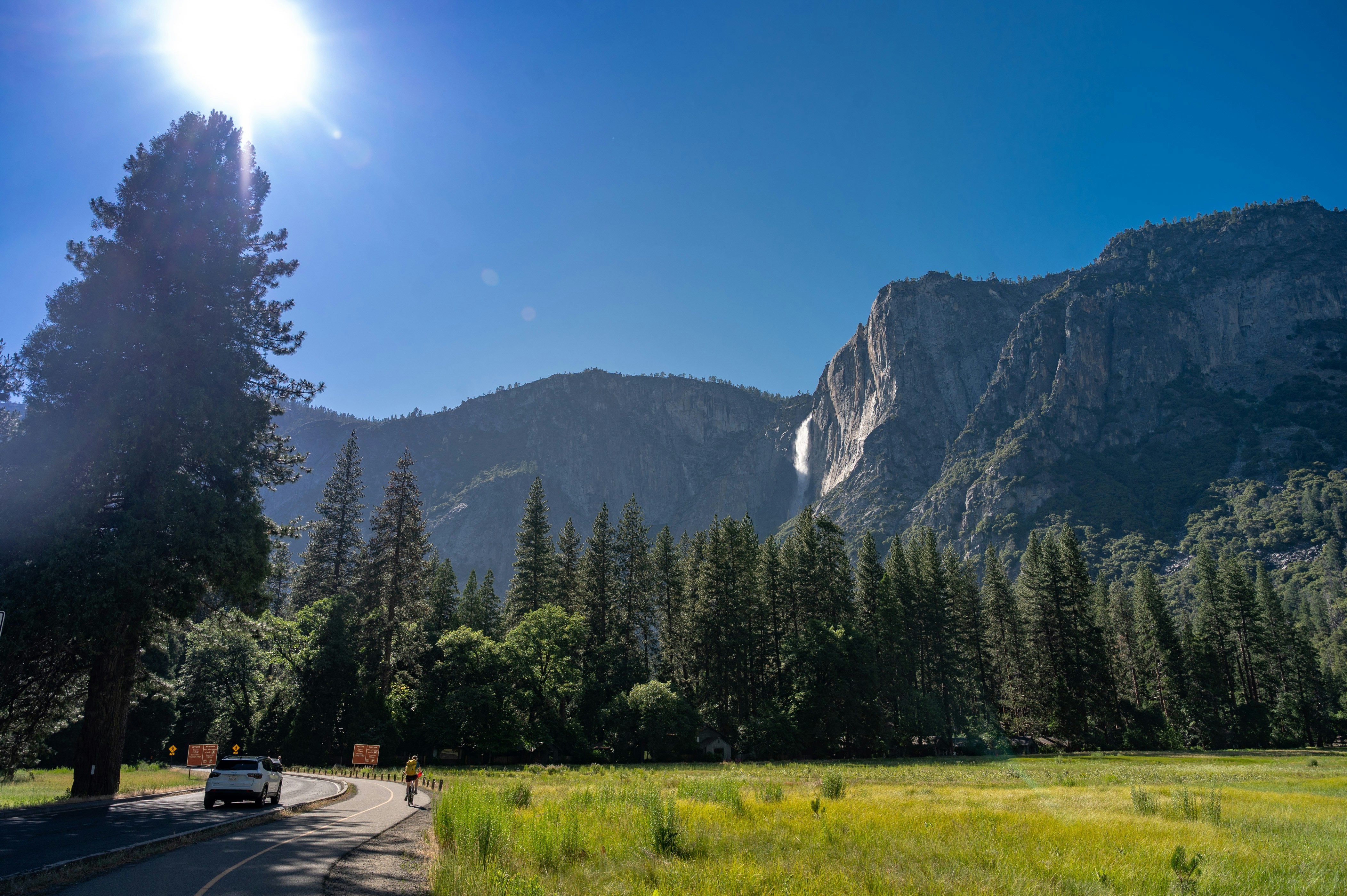 Scenic mountain view with trees and a waterfall.