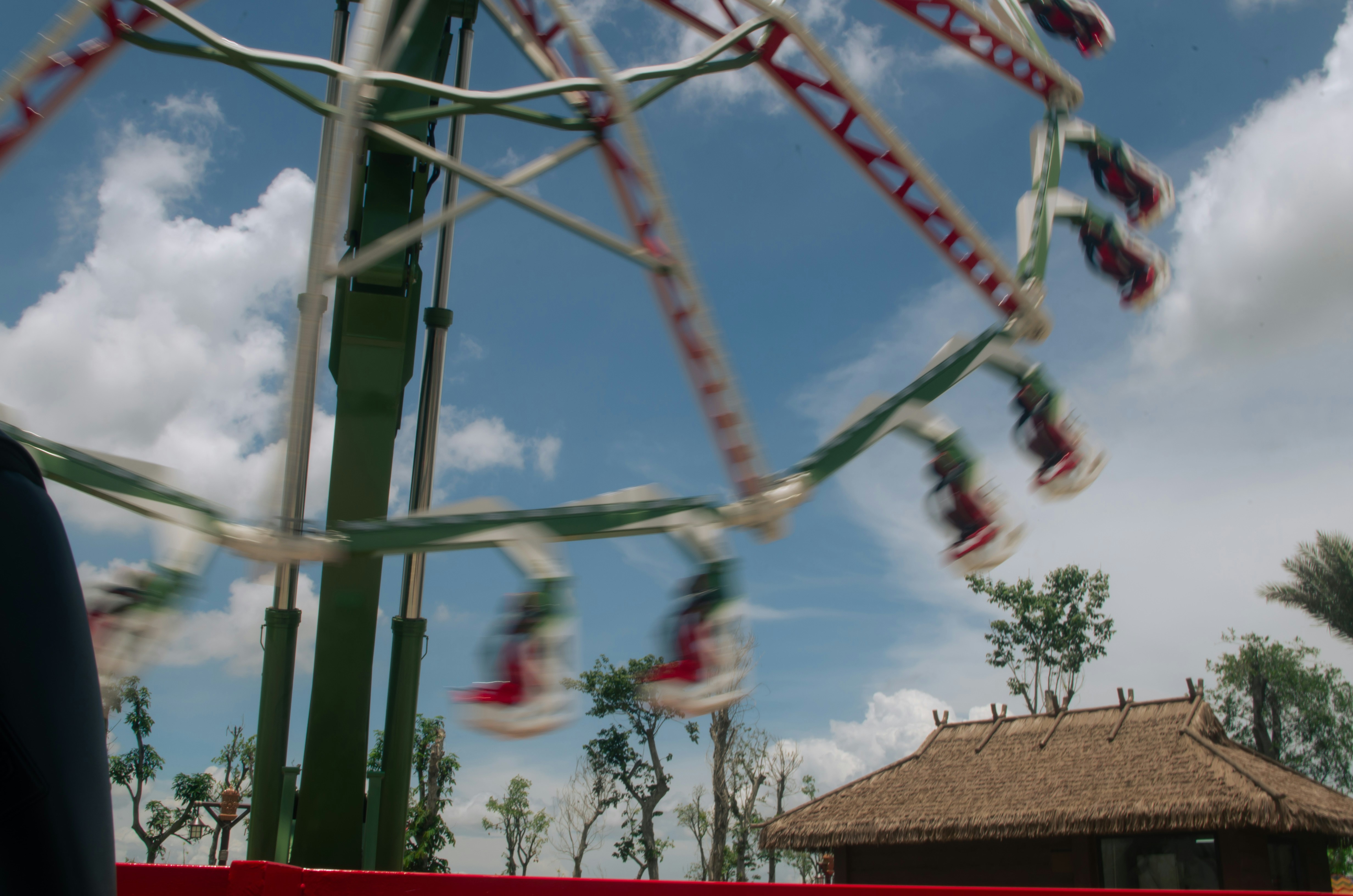 People are enjoying a fast swing ride at an amusement park.