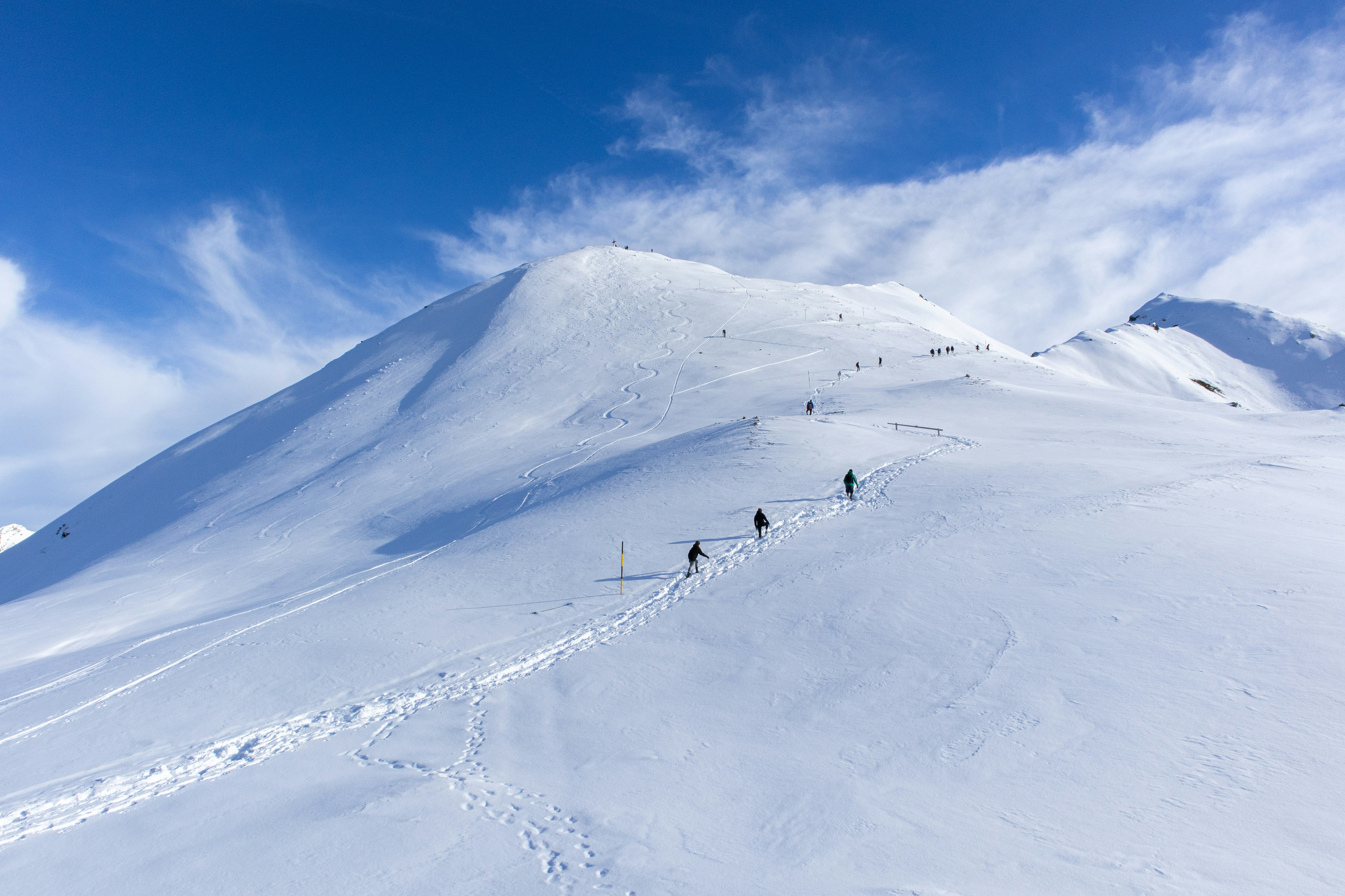 Hikers climb to the top of a mountain in Austria