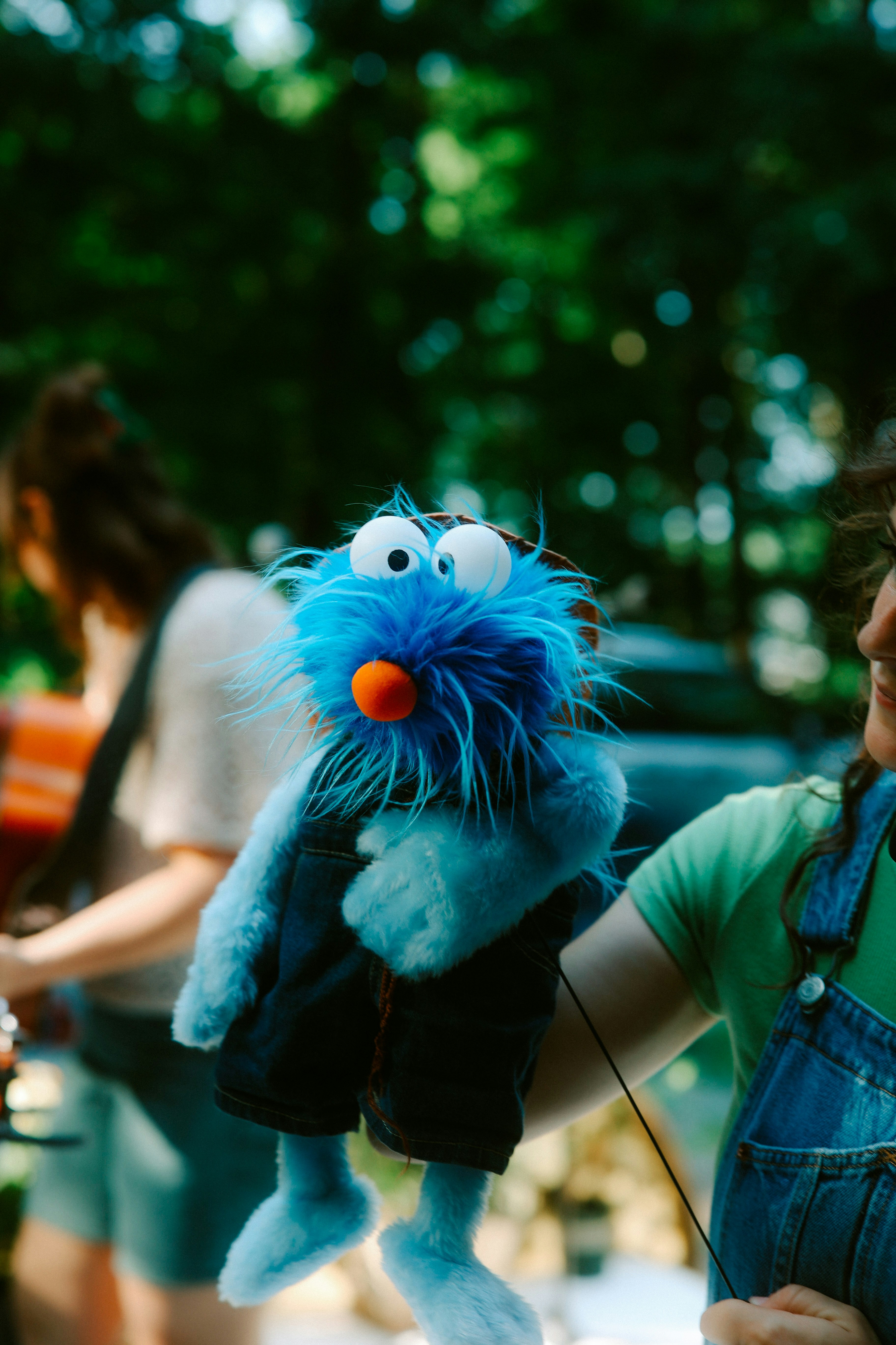 Blue Cookie Monster Puppet in Outdoor Event Handheld Shot