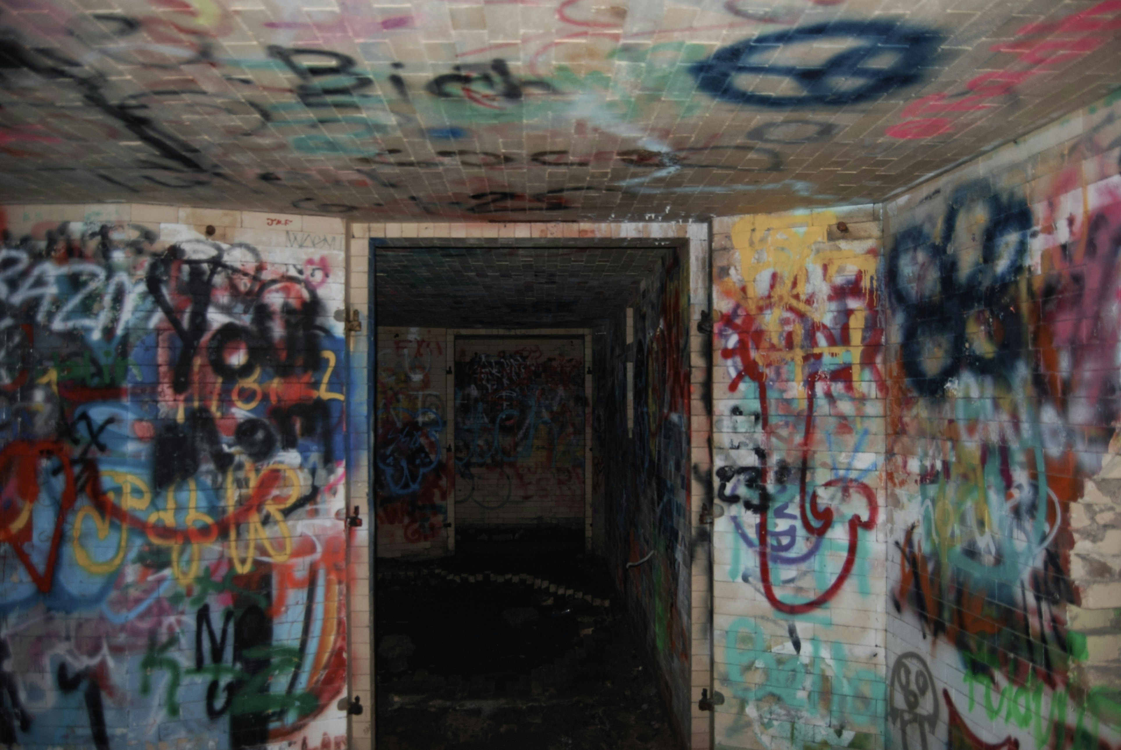 inside of the fort at whetherill park | Graffiti covers the walls and ceiling of an interior.