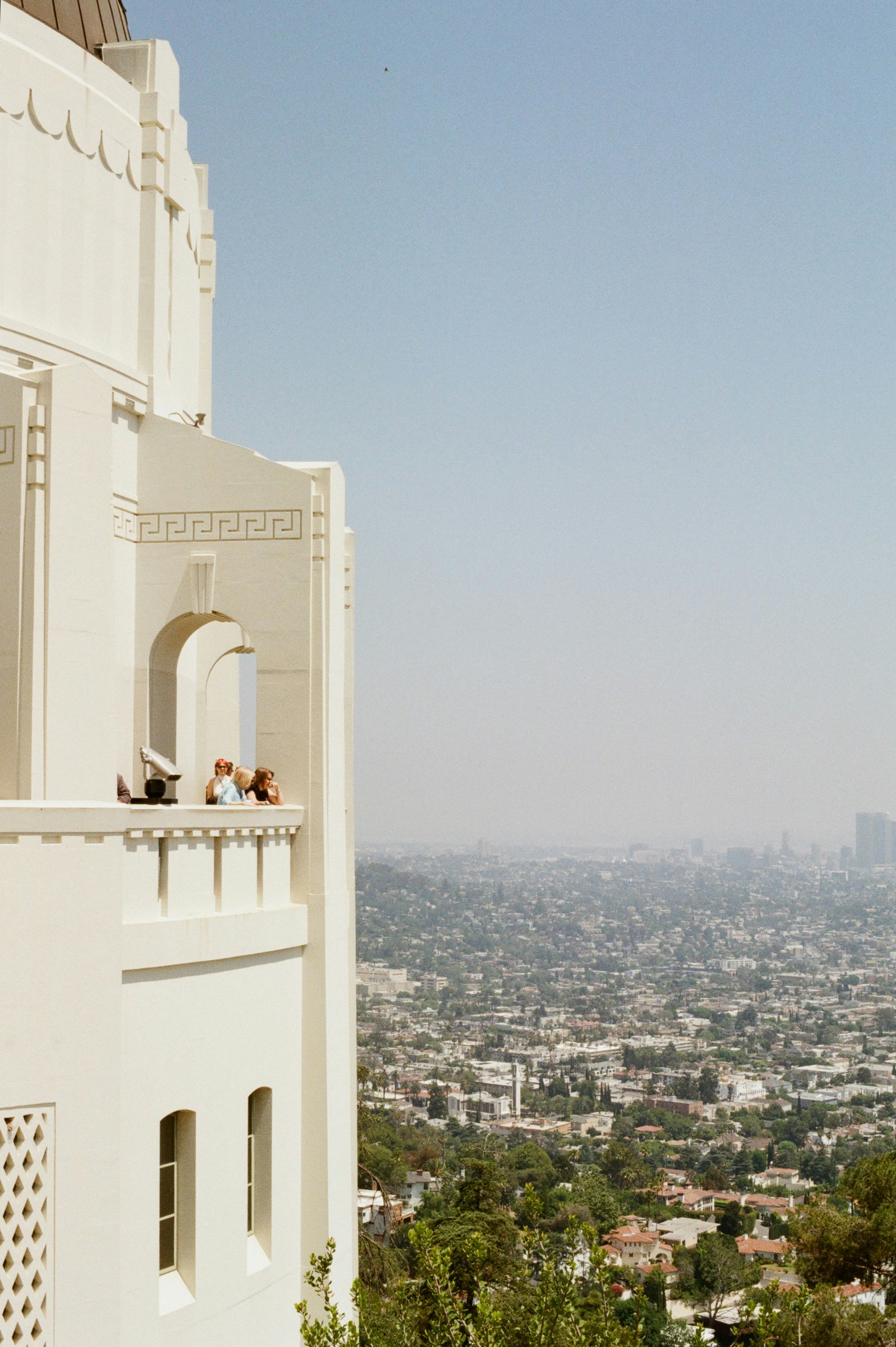 Visitors enjoy panoramic views from the Griffith Observatory, overlooking the sprawling cityscape below.