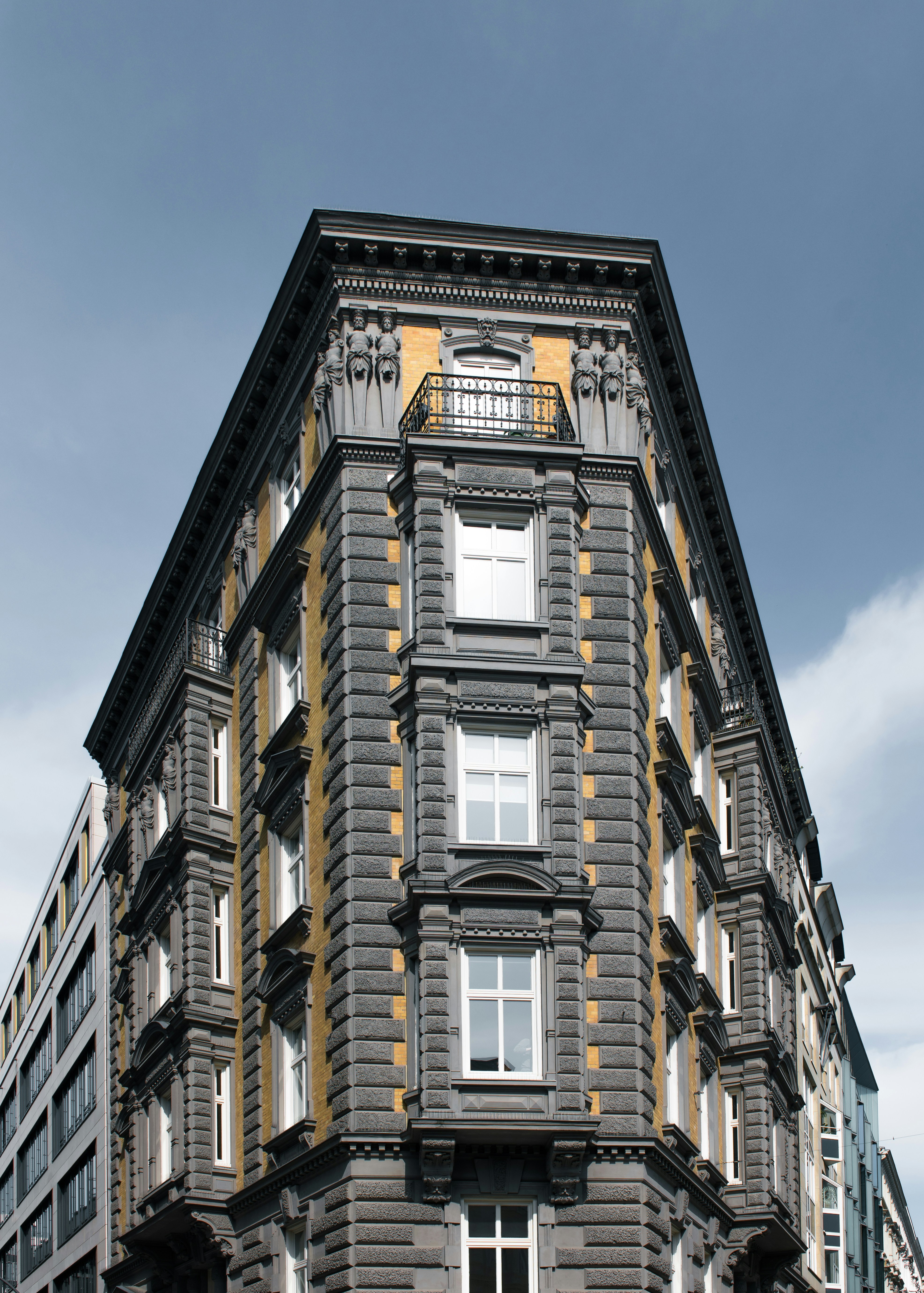 Elegant corner building against a clear blue sky.