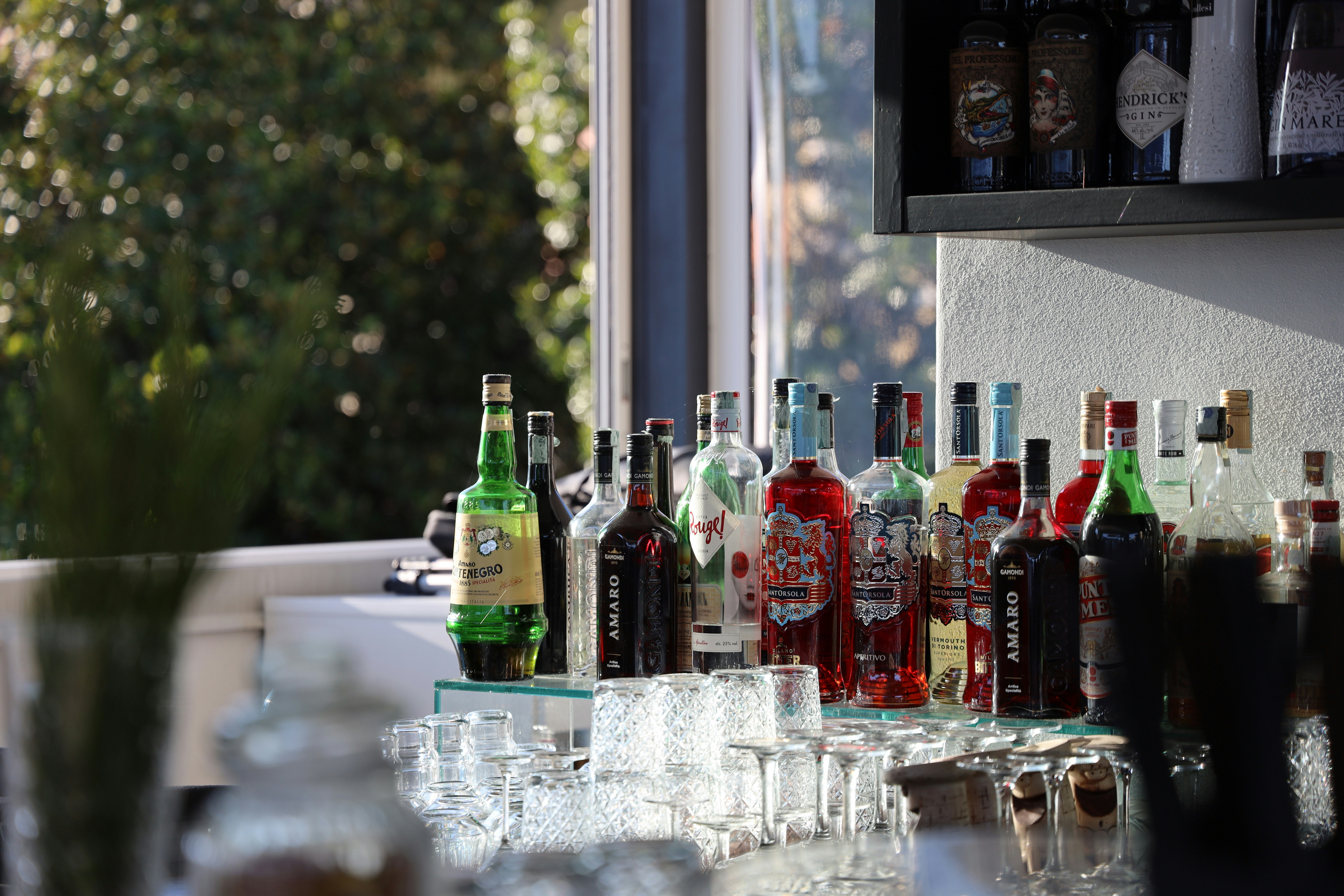 Emerald Bottle in a Sunlit Bar: a Portrait of Glass and Light