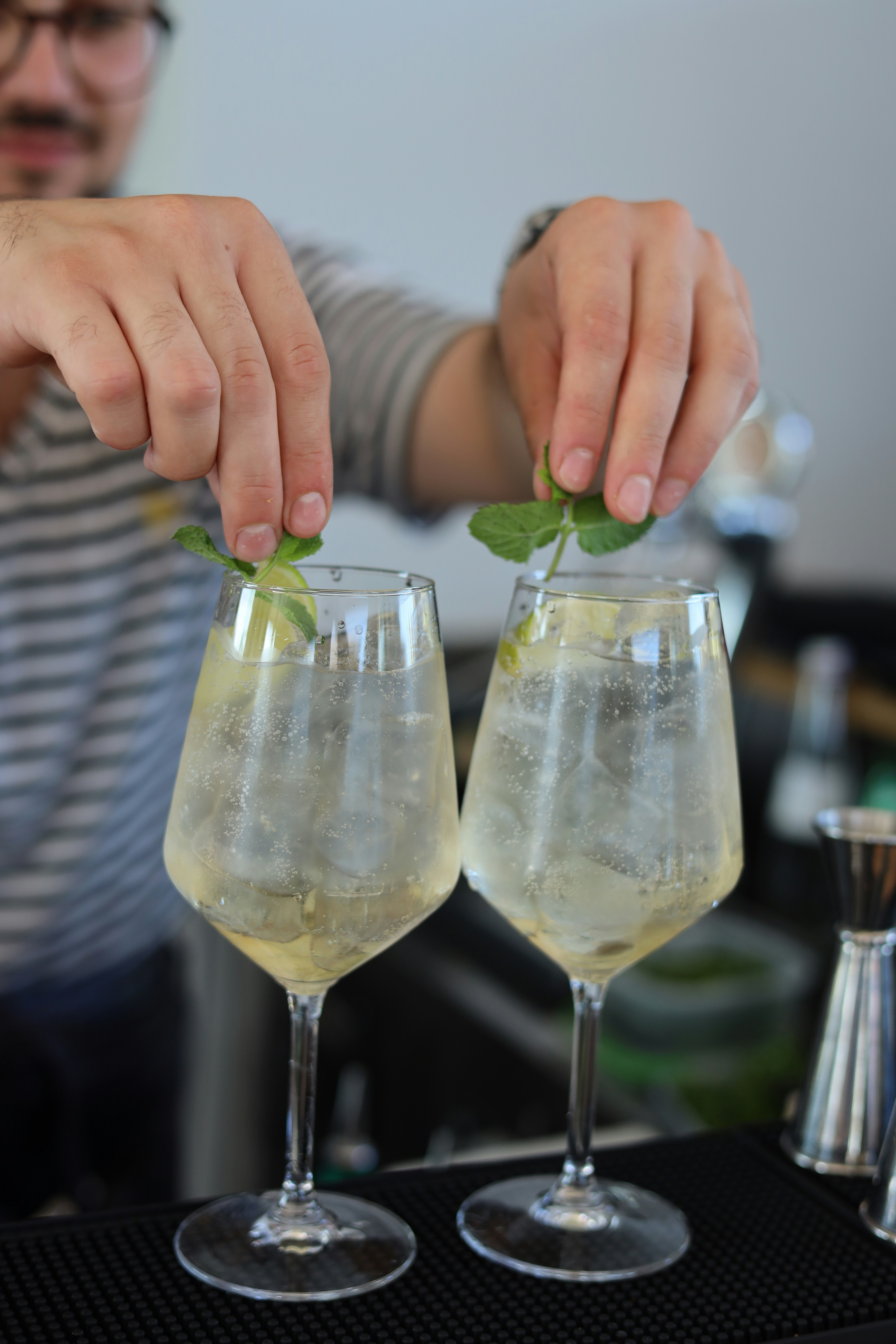 Minted Moments: Two Spritzed Glasses in a Bar's Soft Light