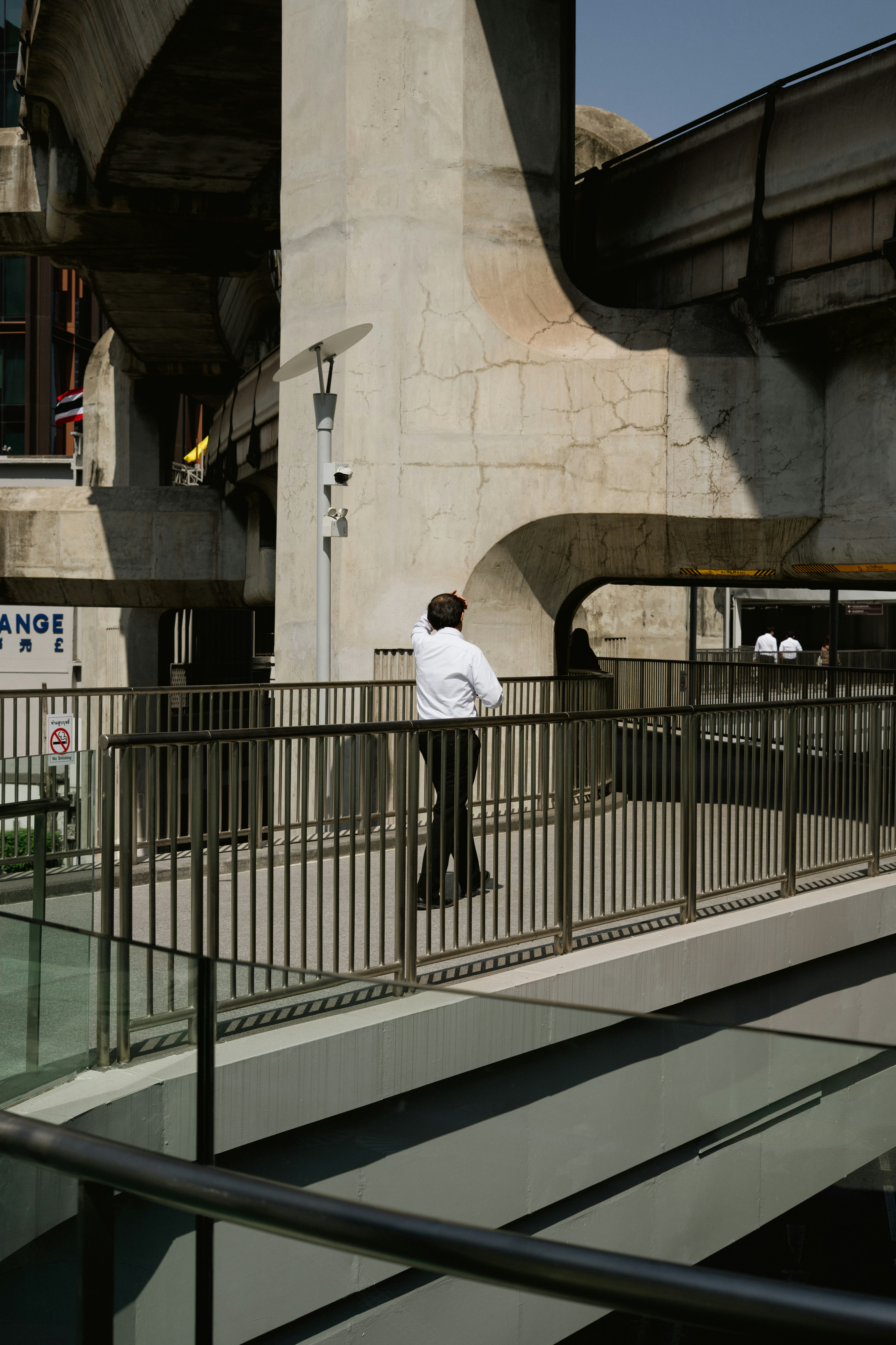 Brutalist Walkway: A Quiet Portrait Amid Concrete Arches
