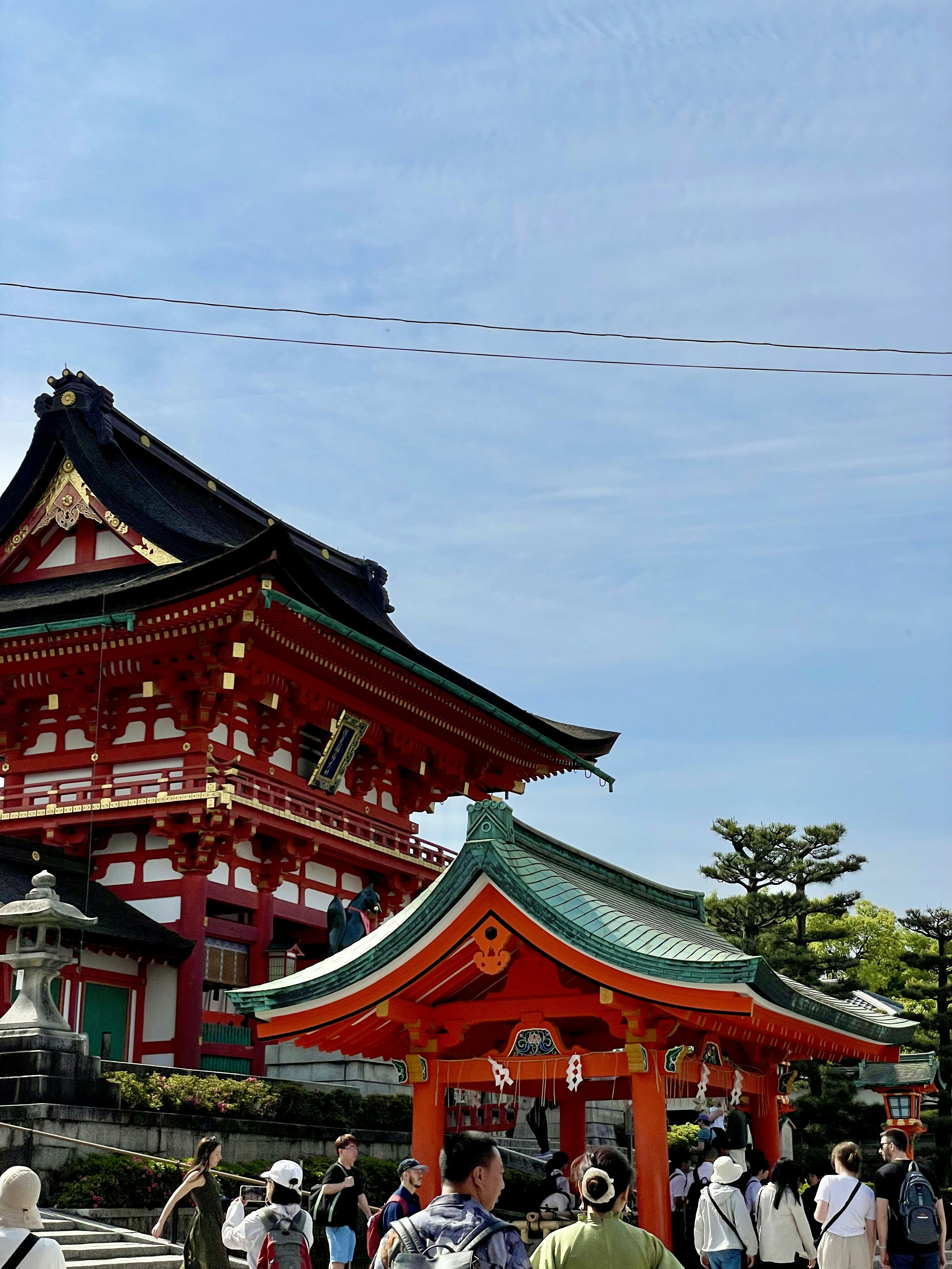 Japanese temple buildings under a bright sky.